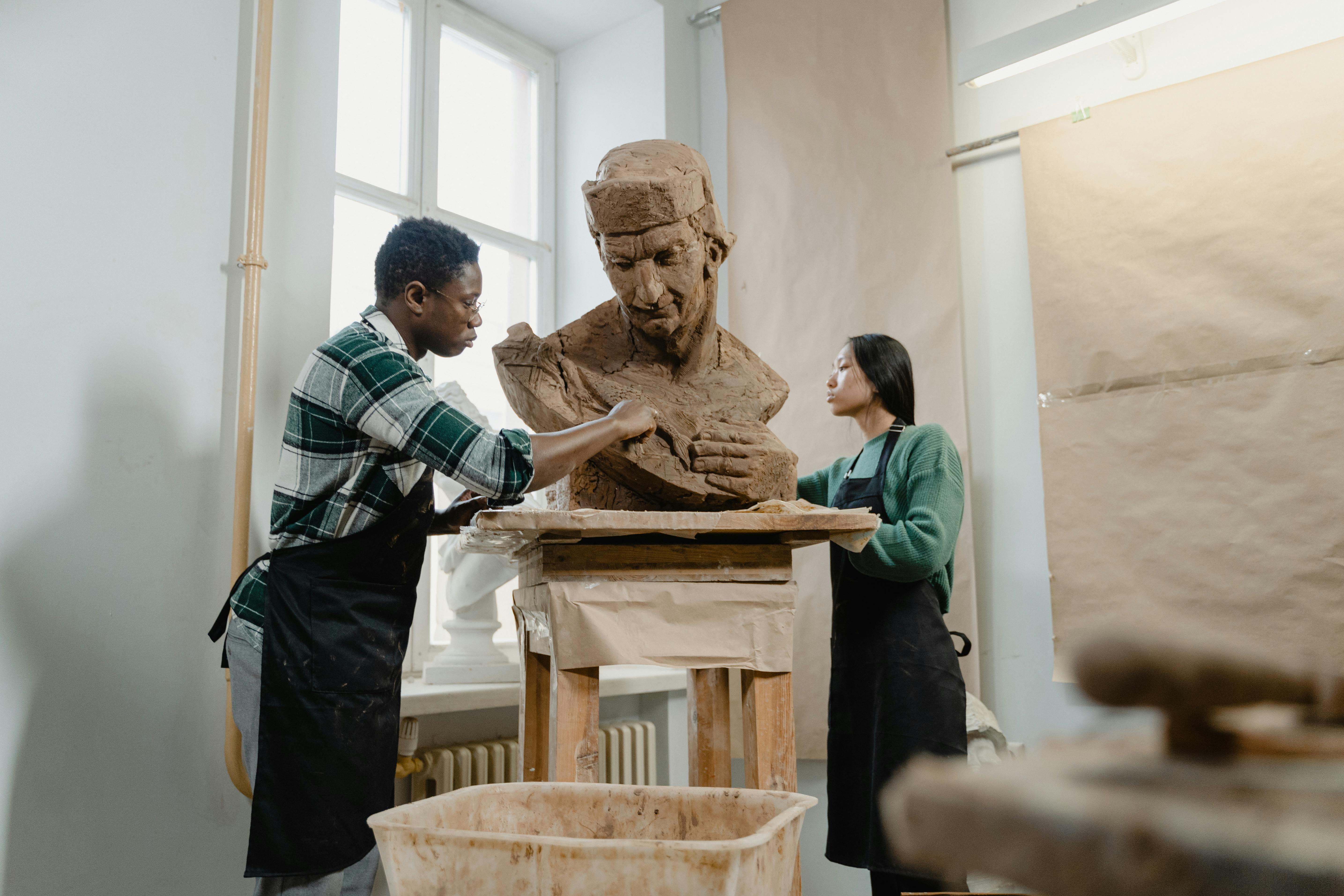 Artists Sculpting Clay into a Statue · Free Stock Photo