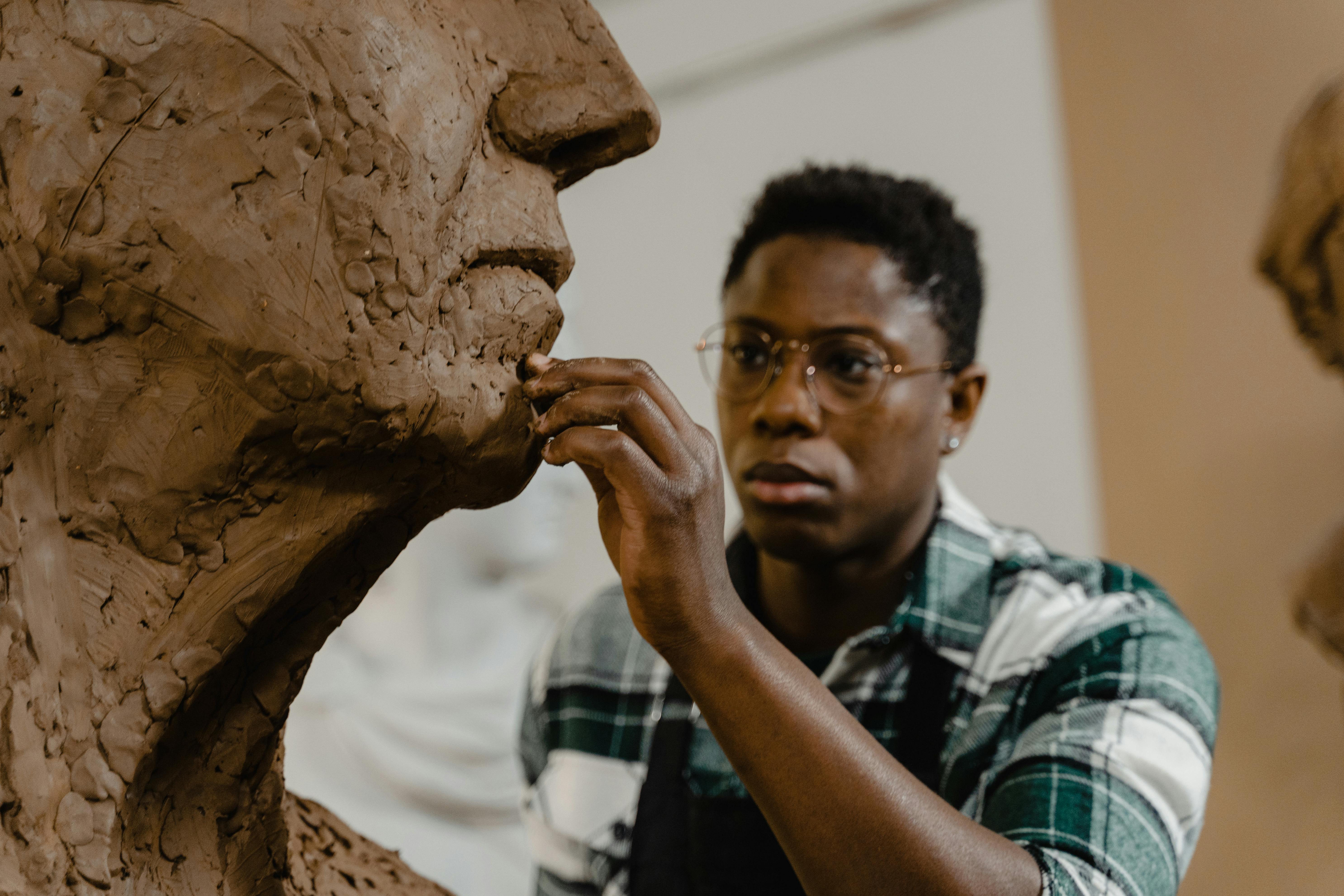 A Man Working on a Clay Sculpture · Free Stock Photo