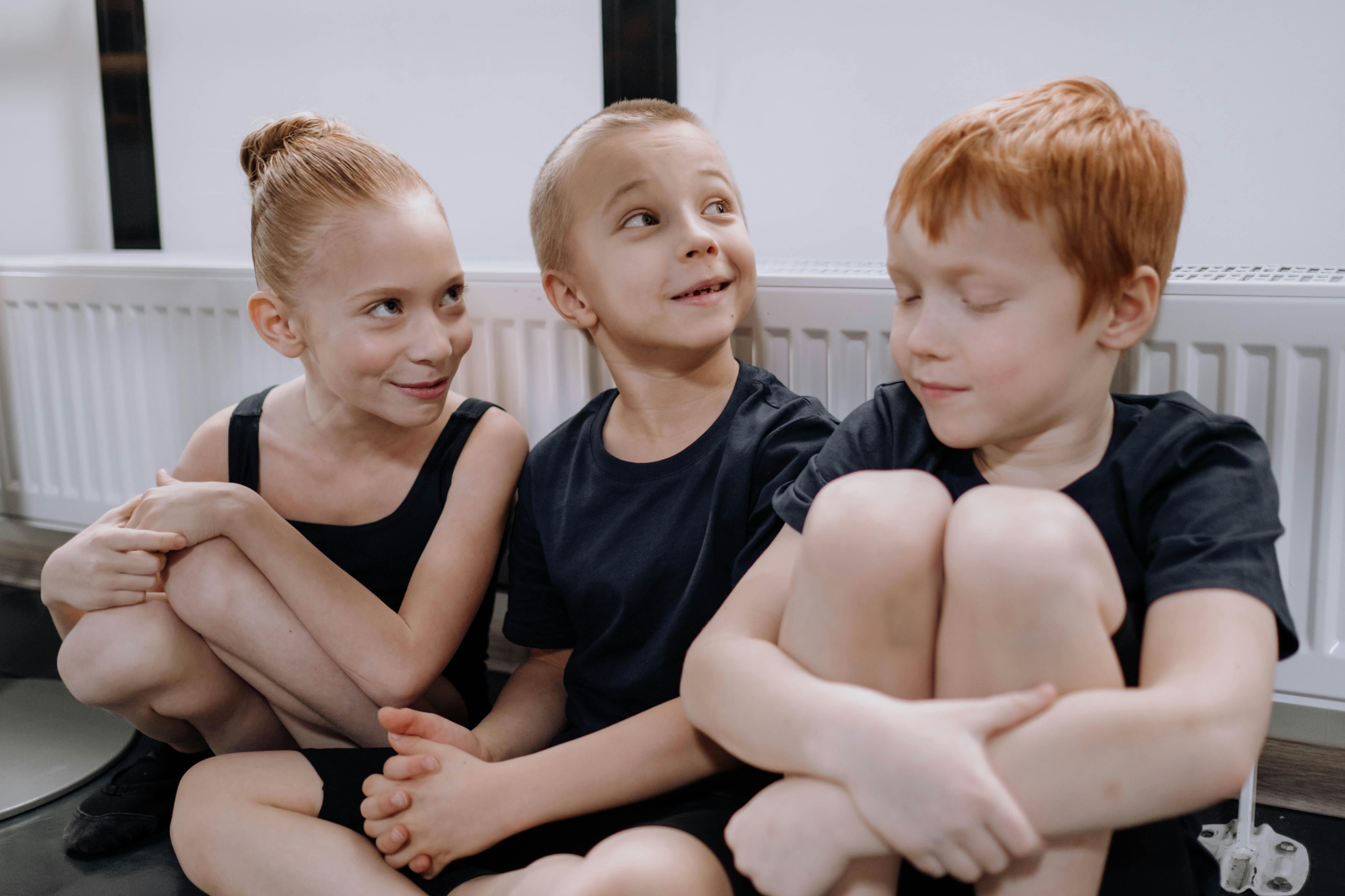 Children Ballerinos and Ballerina Sitting by Radiator · Free Stock Photo