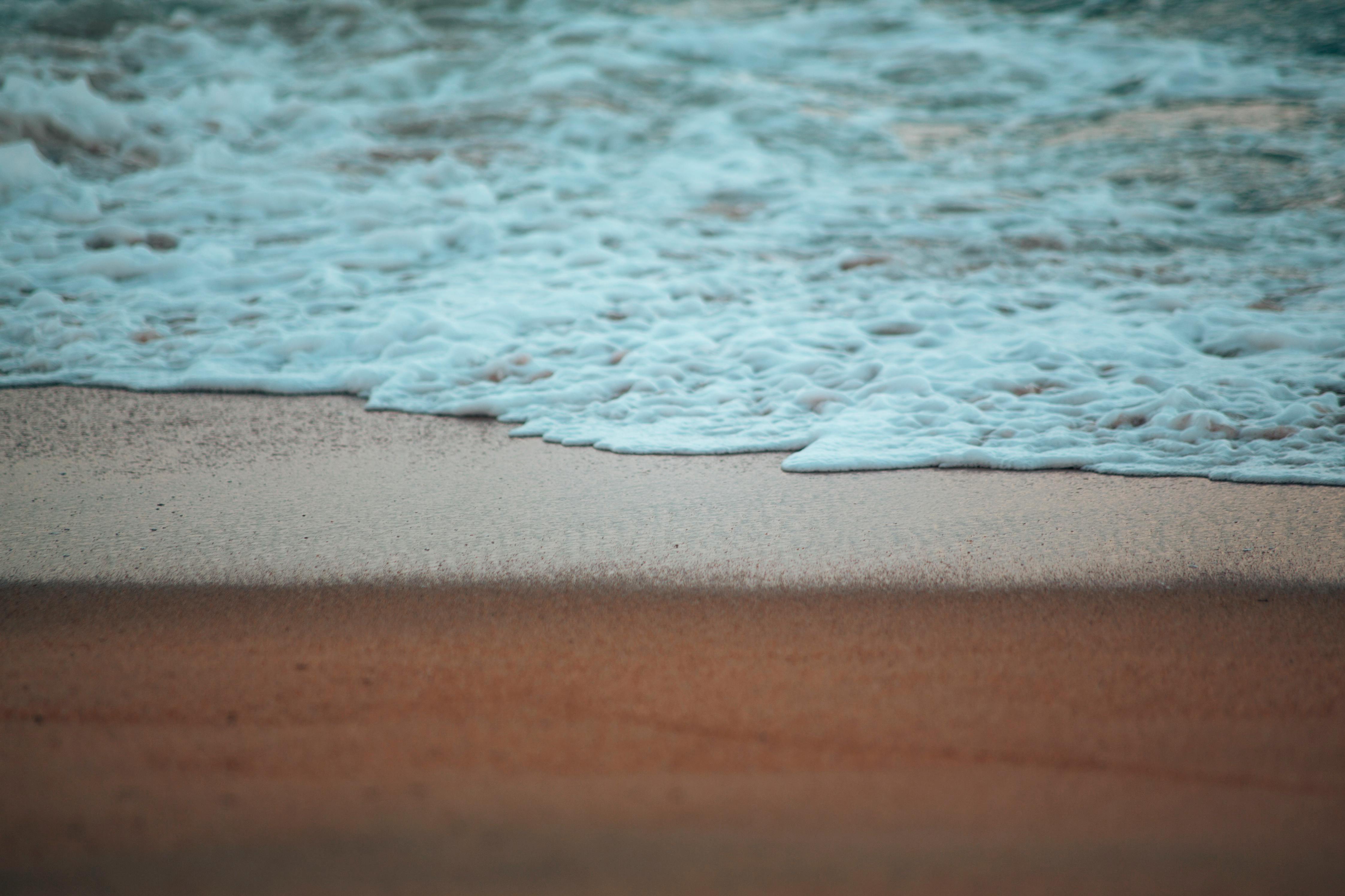 Tropical sea with sandy shore in sunlight · Free Stock Photo