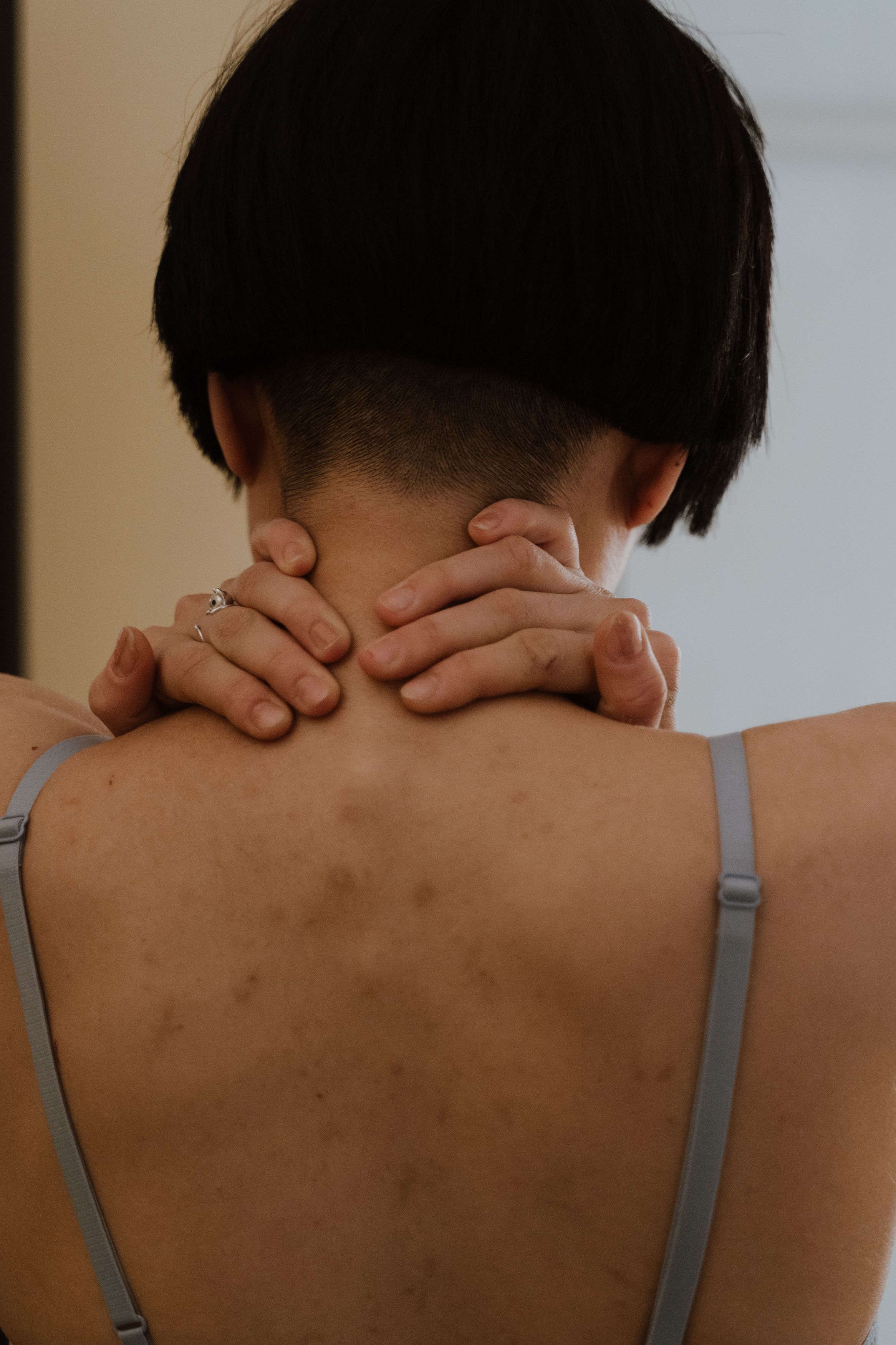 Back View of Person Holding Her Neck · Free Stock Photo
