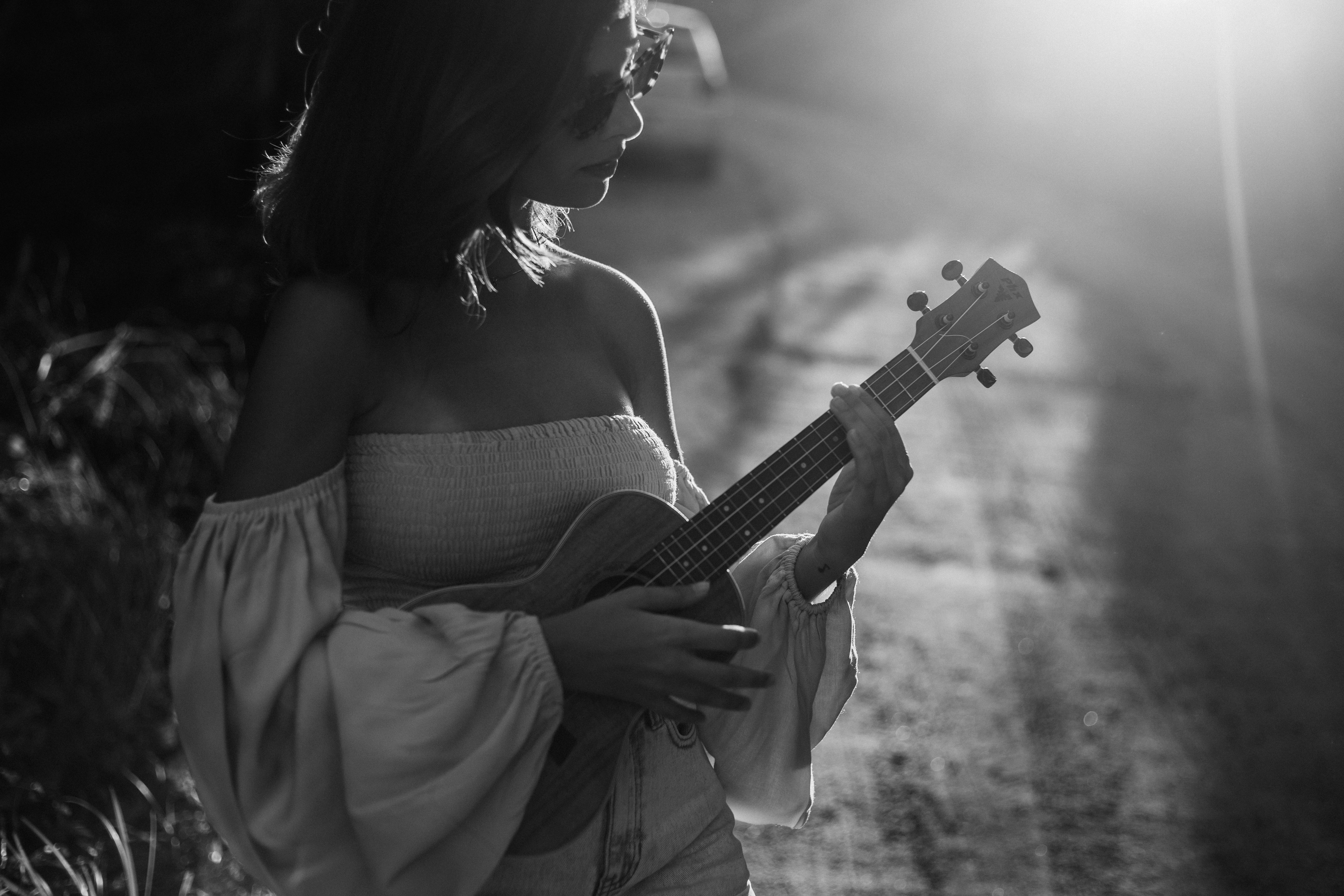 Grayscale Photo of a Woman Playing the Ukulele · Free Stock Photo