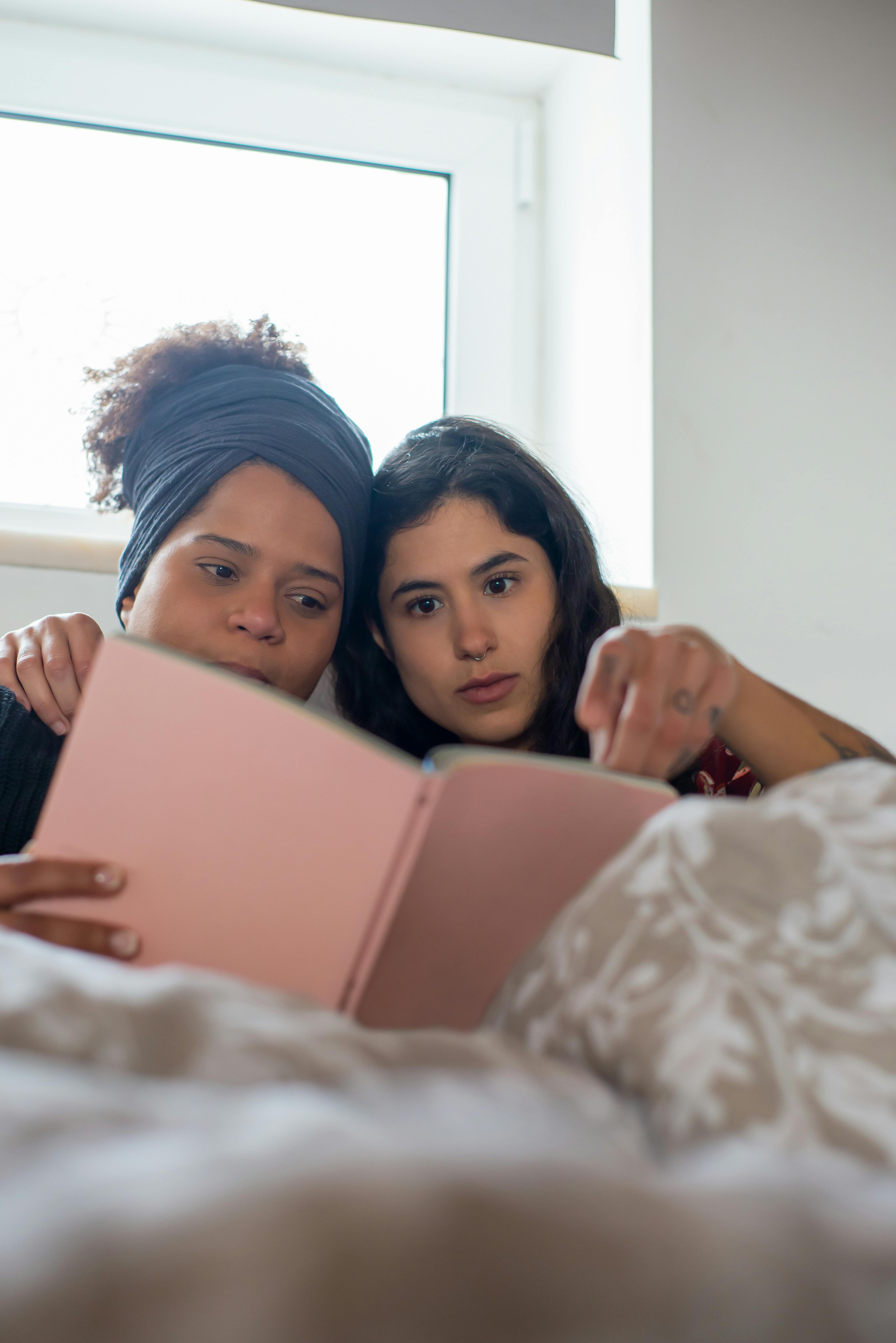 Man and Woman Reading a Book Together · Free Stock Photo