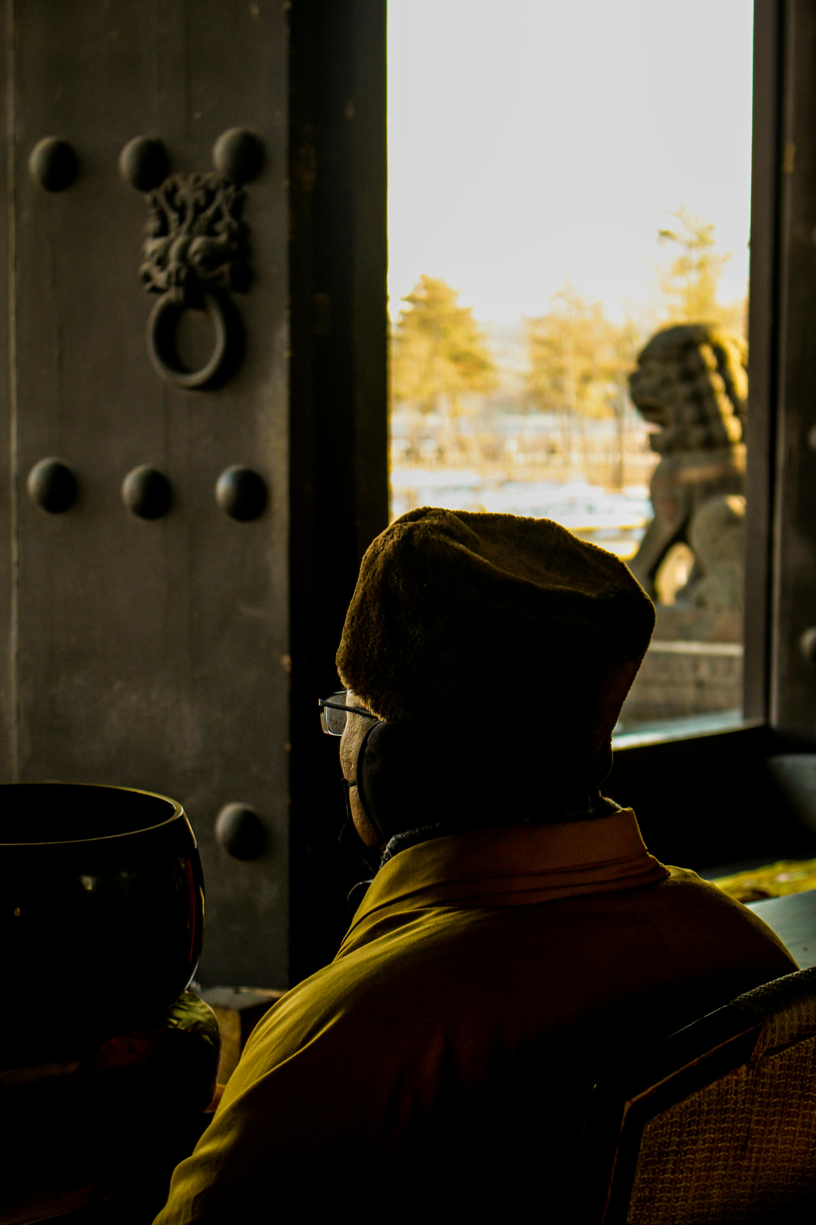 Monk Looking out Temple Window · Free Stock Photo