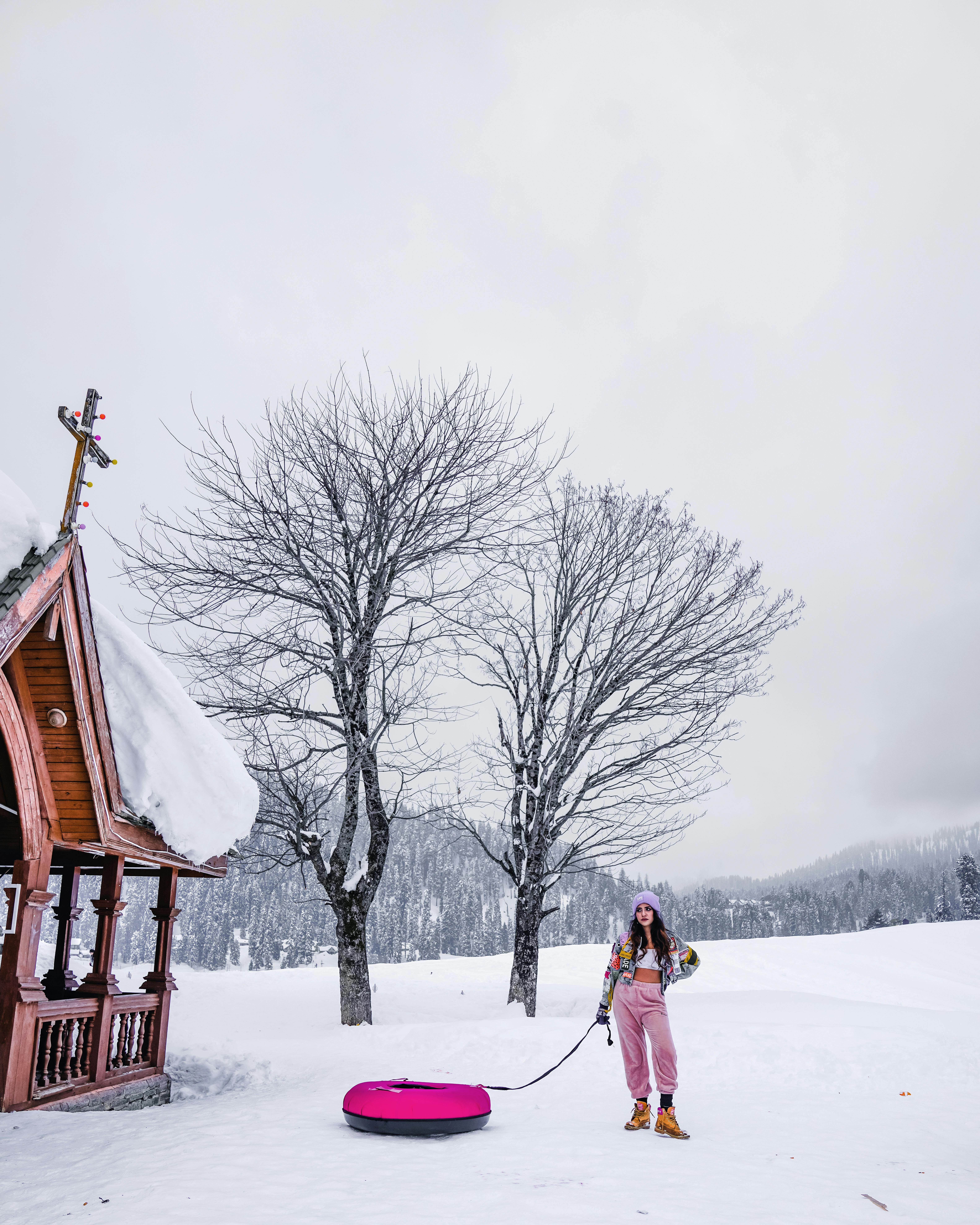 Woman Holding Sled While Standing on Snow · Free Stock Photo