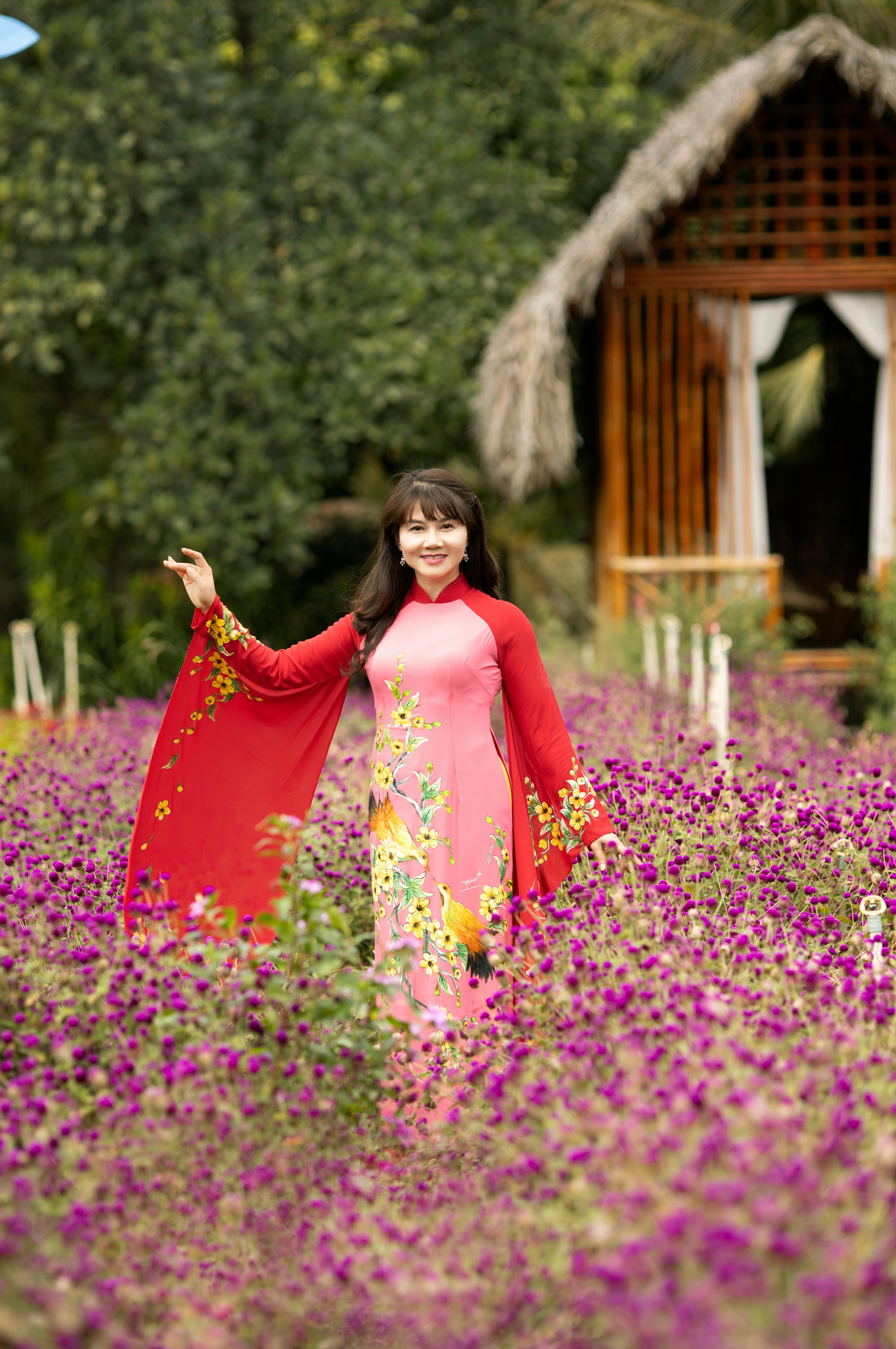 A Woman Wearing Traditional Clothes in a Flower Field · Free Stock Photo