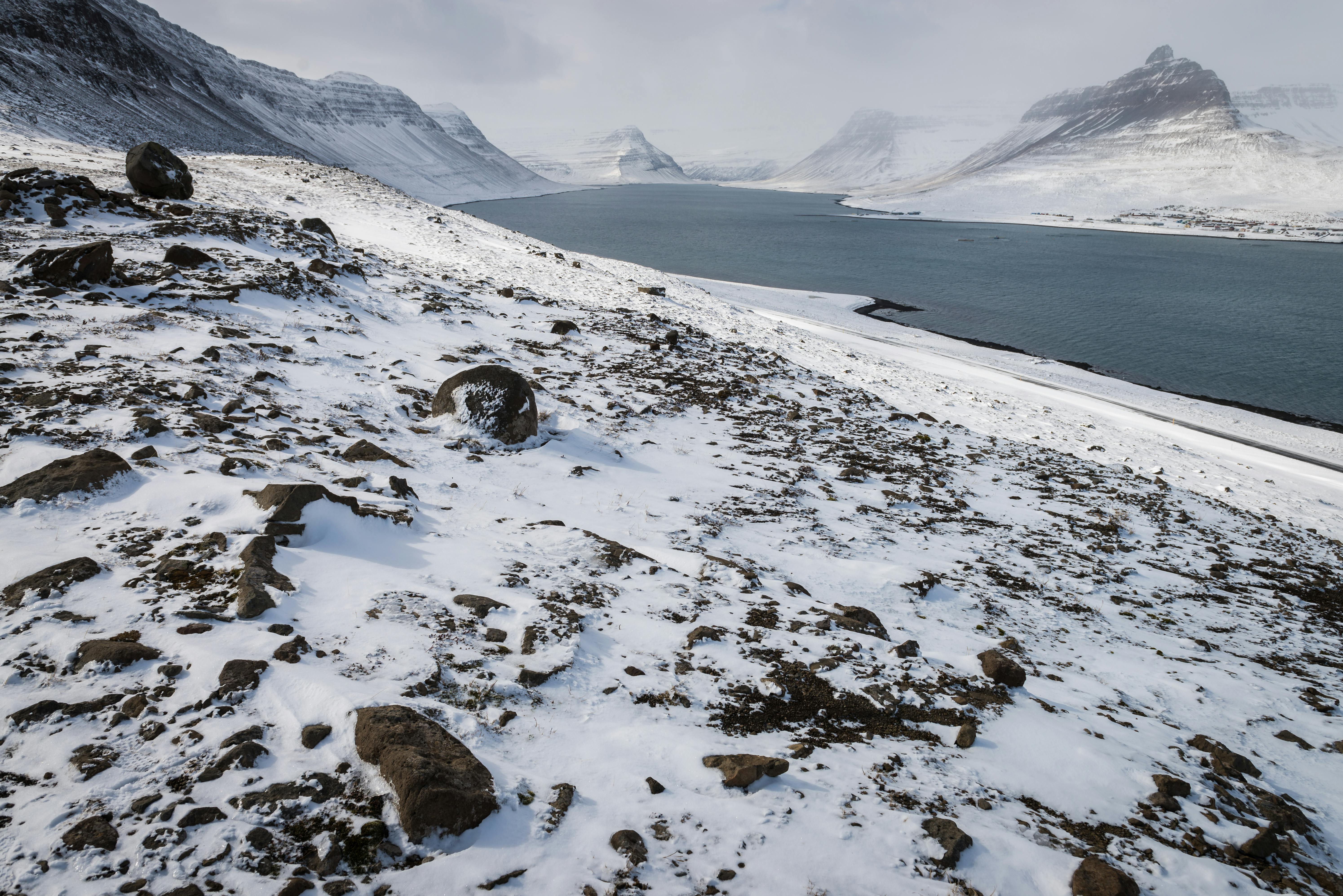 A Snow Covered Mountainous Shoreline during Winter · Free Stock Photo