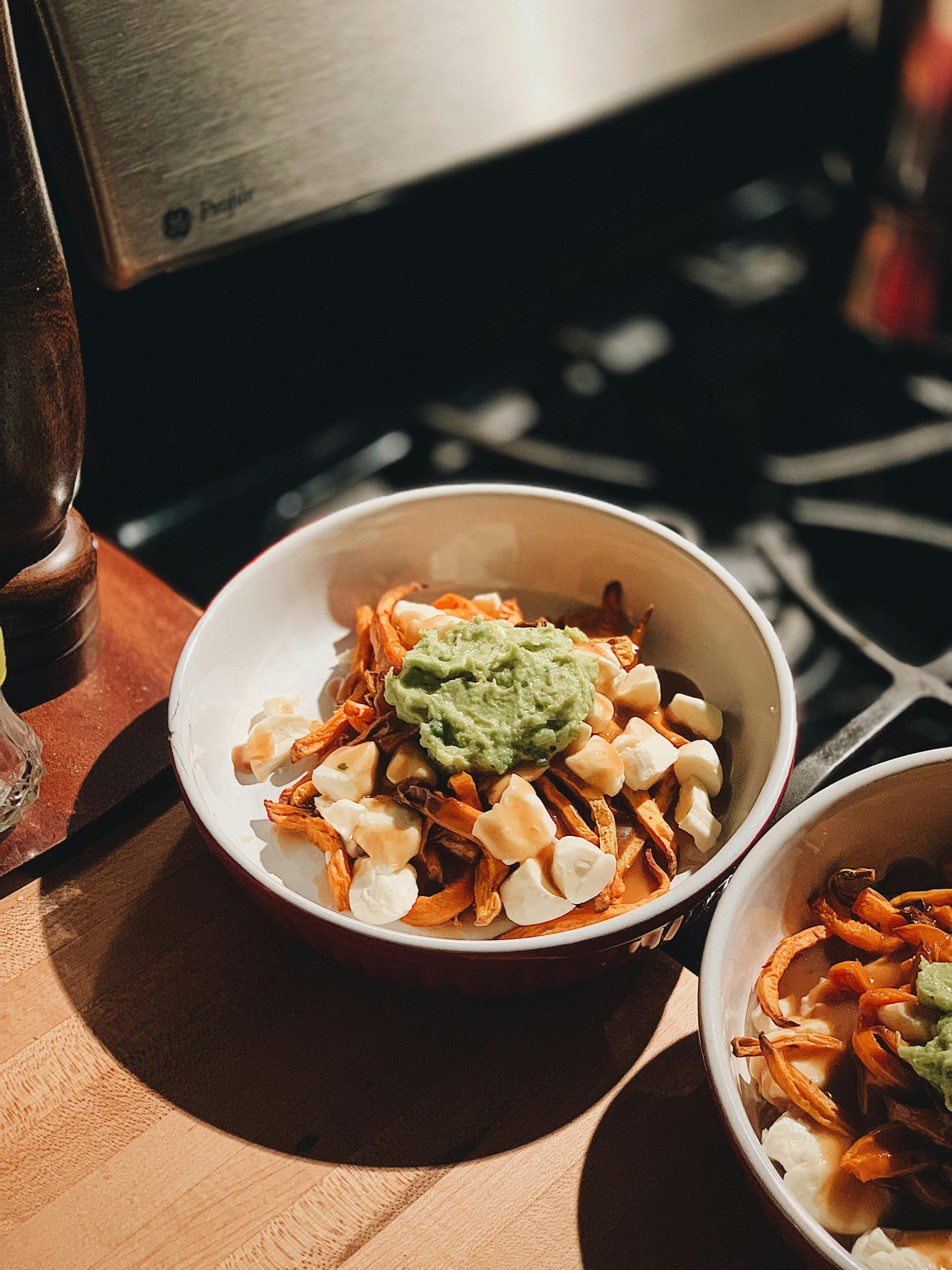 A Red Round Fruit on Dark Sauced Food · Free Stock Photo