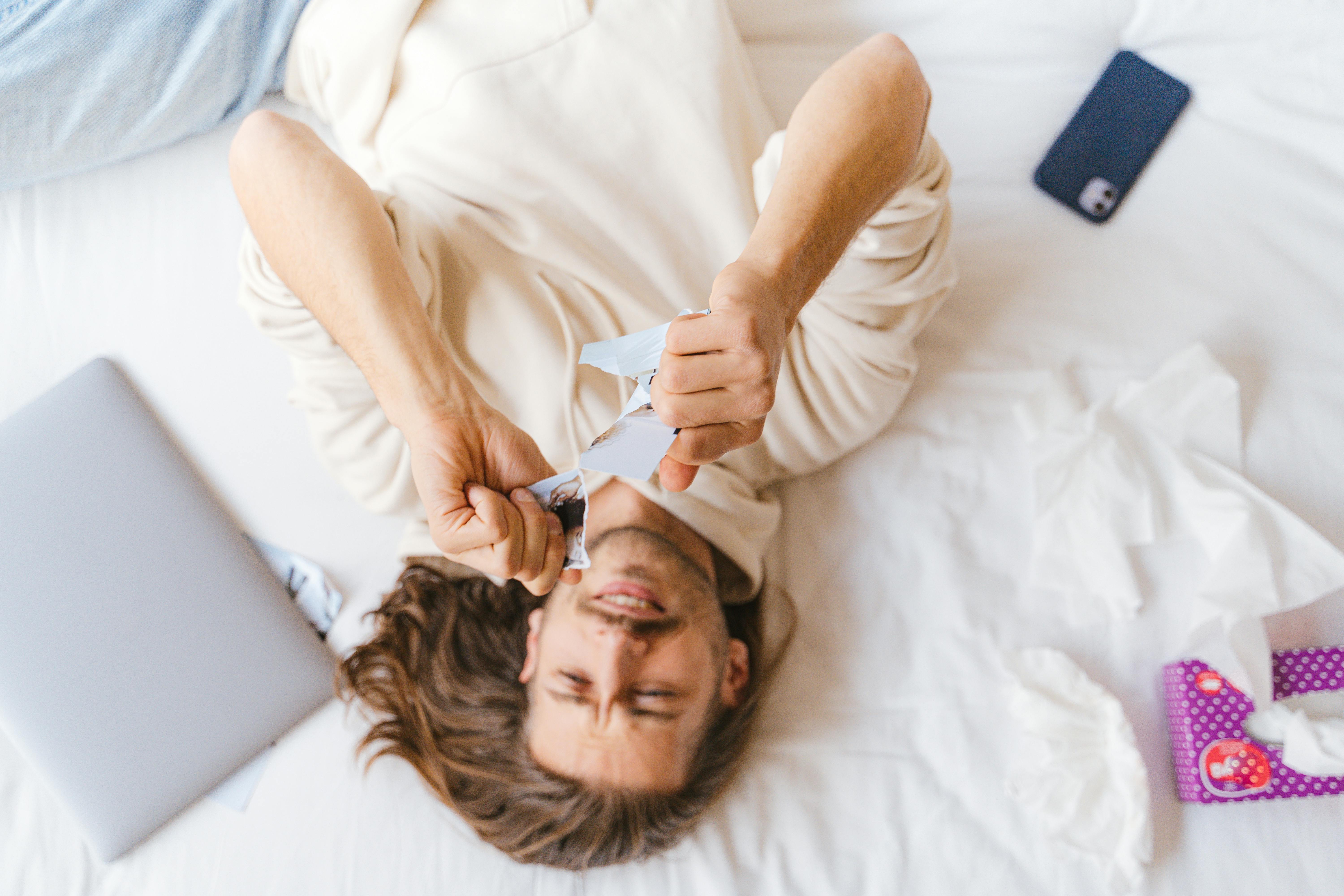 A Man Tearing a Photo · Free Stock Photo