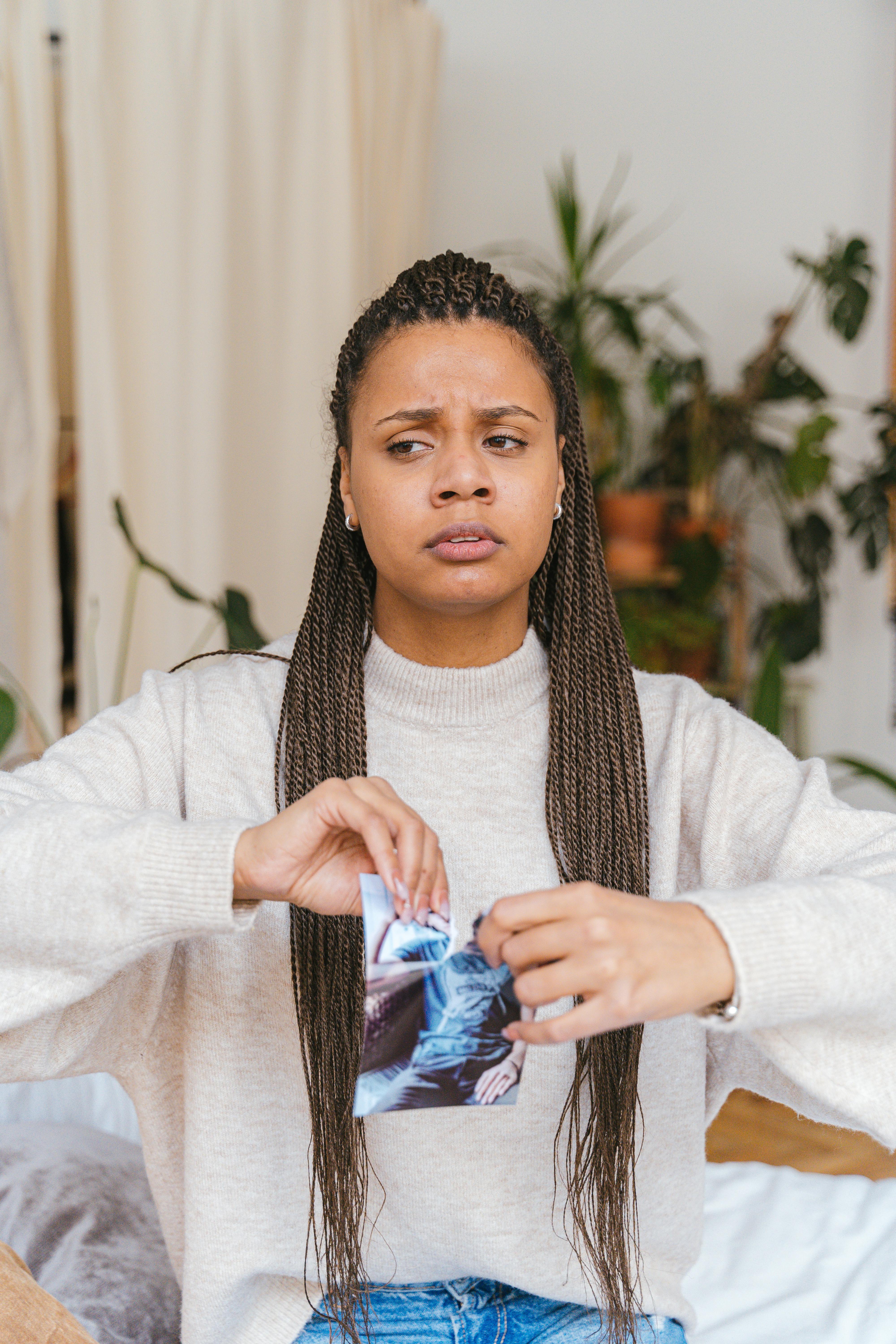 A Woman Tearing a Photo · Free Stock Photo