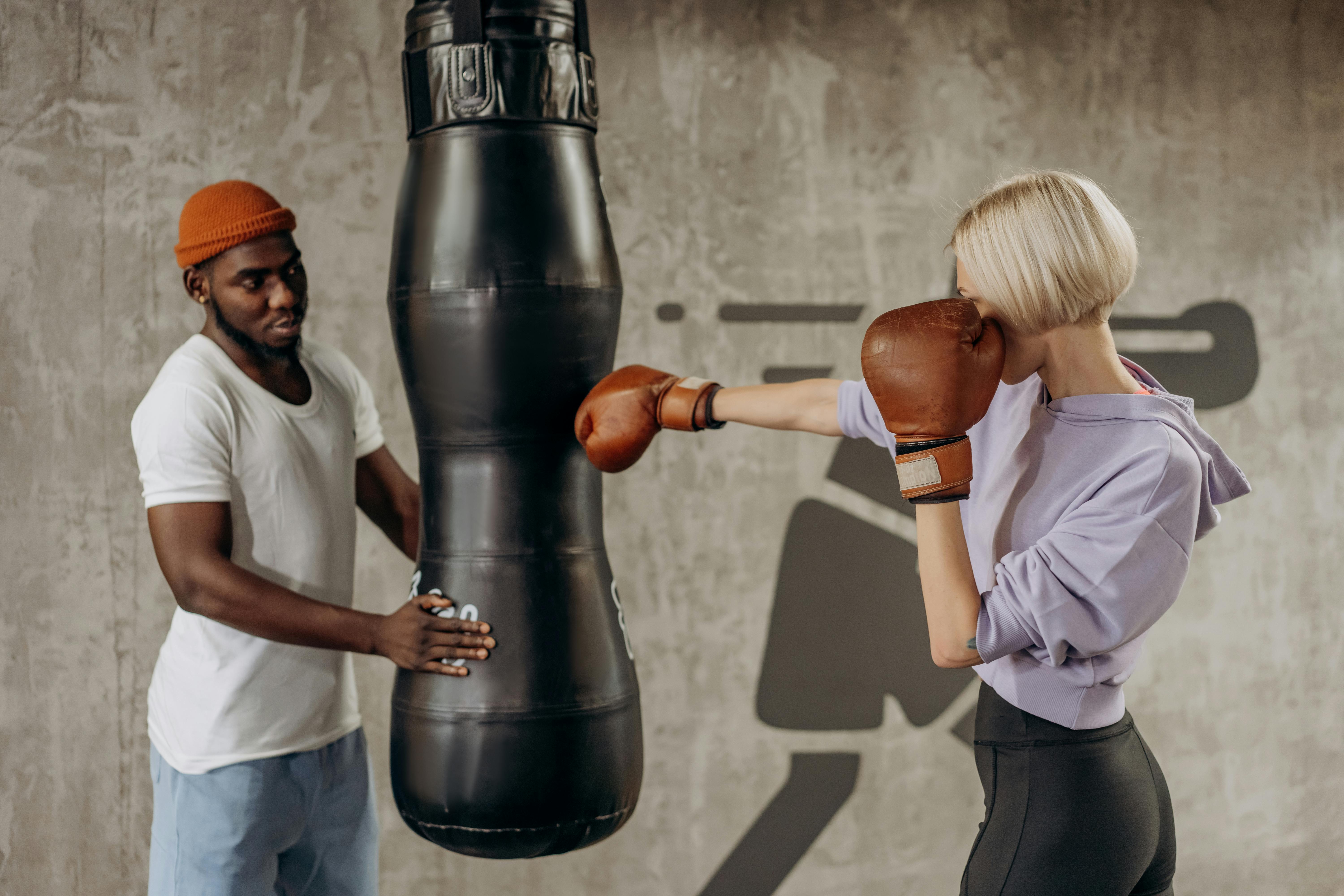 A Woman Punching a Heavy Bag · Free Stock Photo