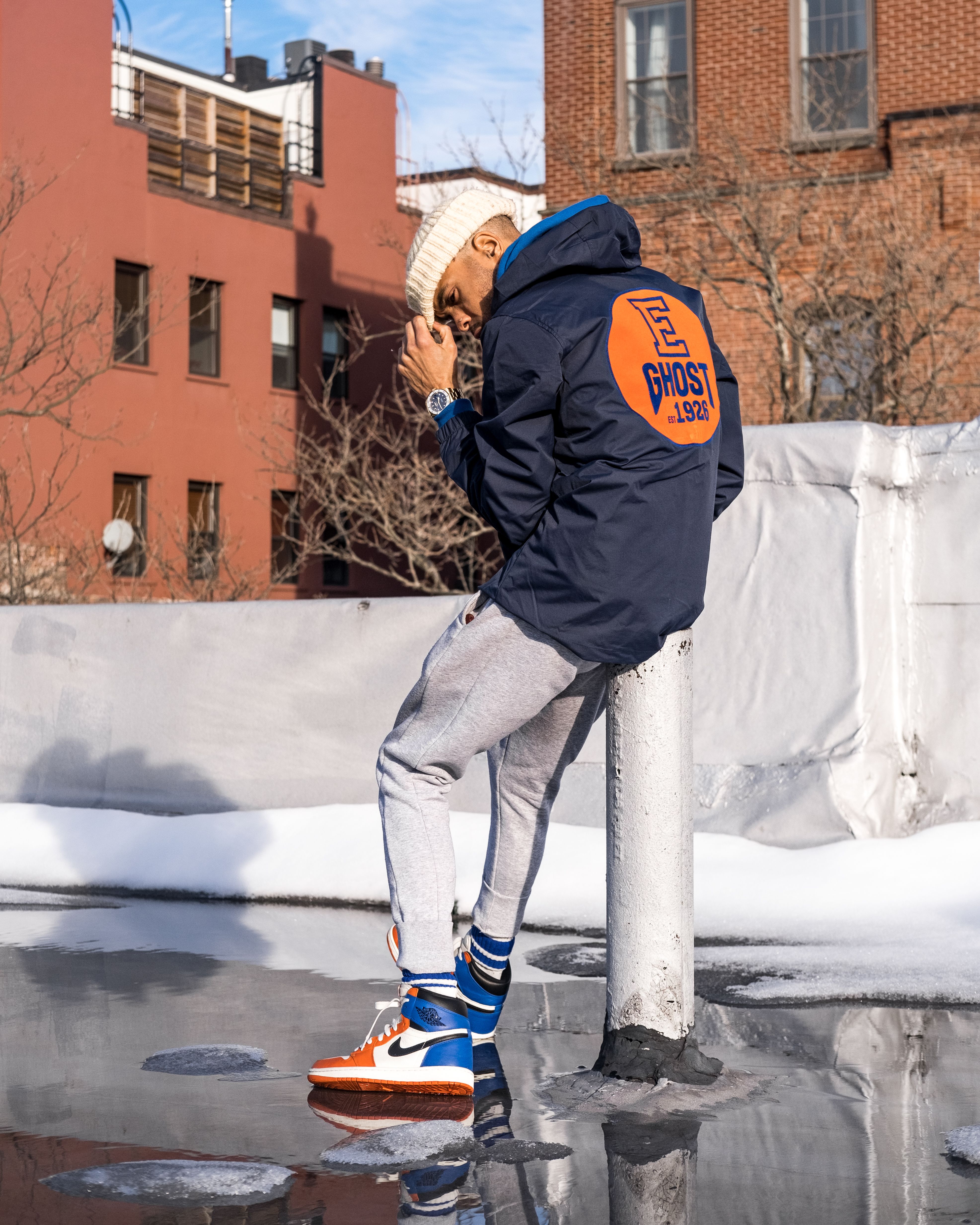 Fashionable Young Man Sitting on a Pole · Free Stock Photo