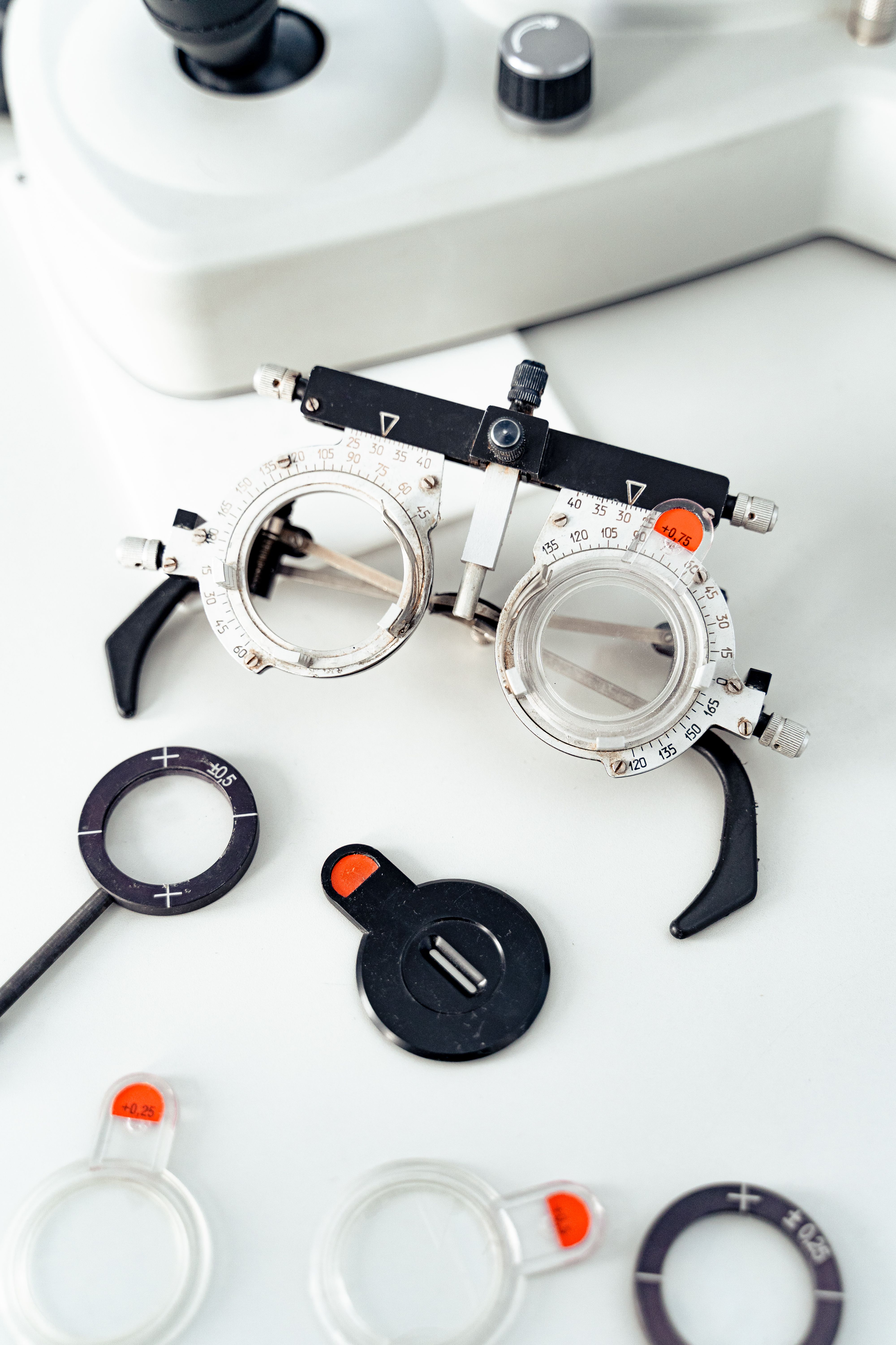 Trial Frame and Trial Lenses on a White Surface · Free Stock Photo