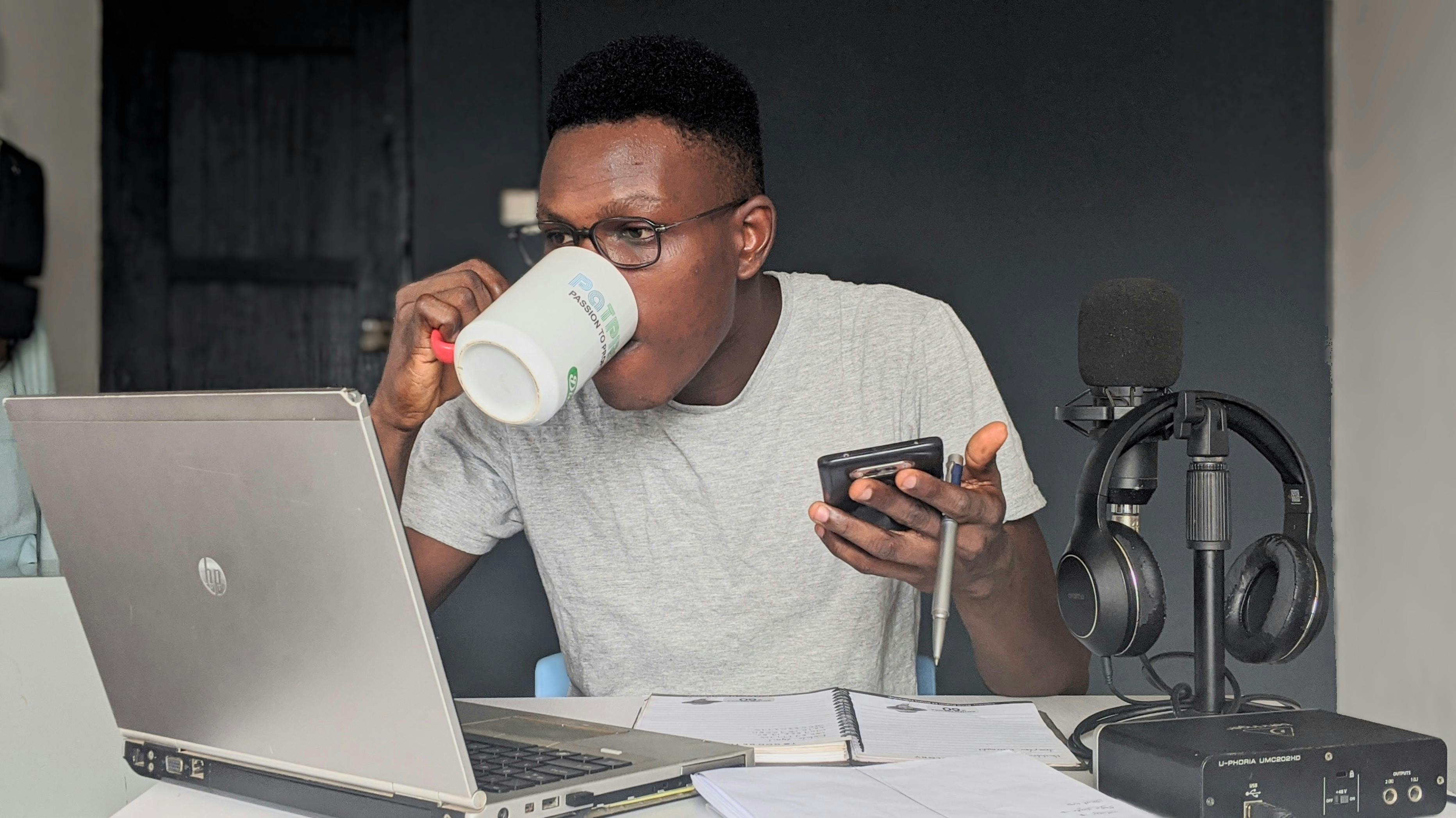 Man Drinking Coffee while Looking at Laptop · Free Stock Photo