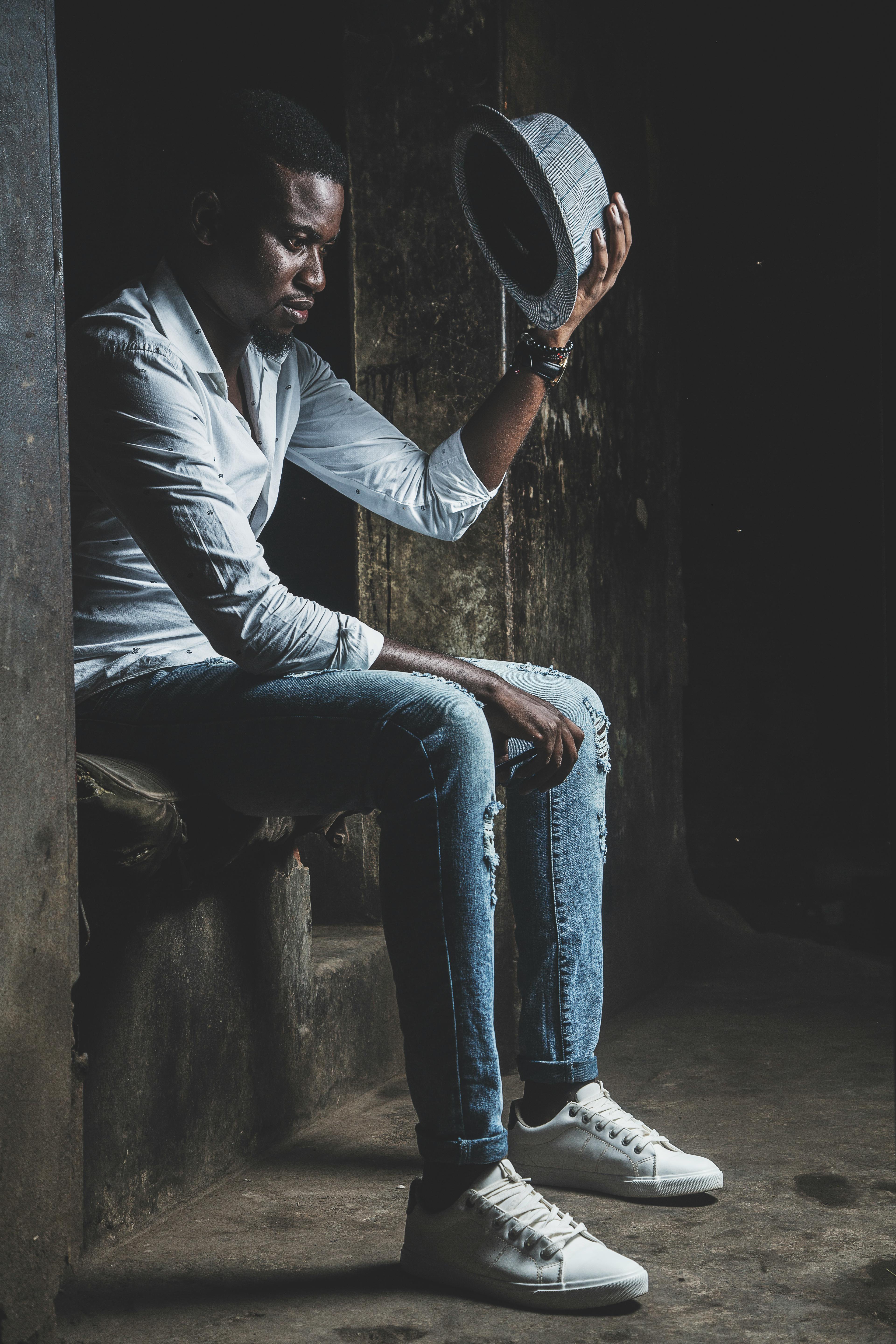 A Man Holding His Pin Button while Wearing a Denim Jacket · Free Stock ...