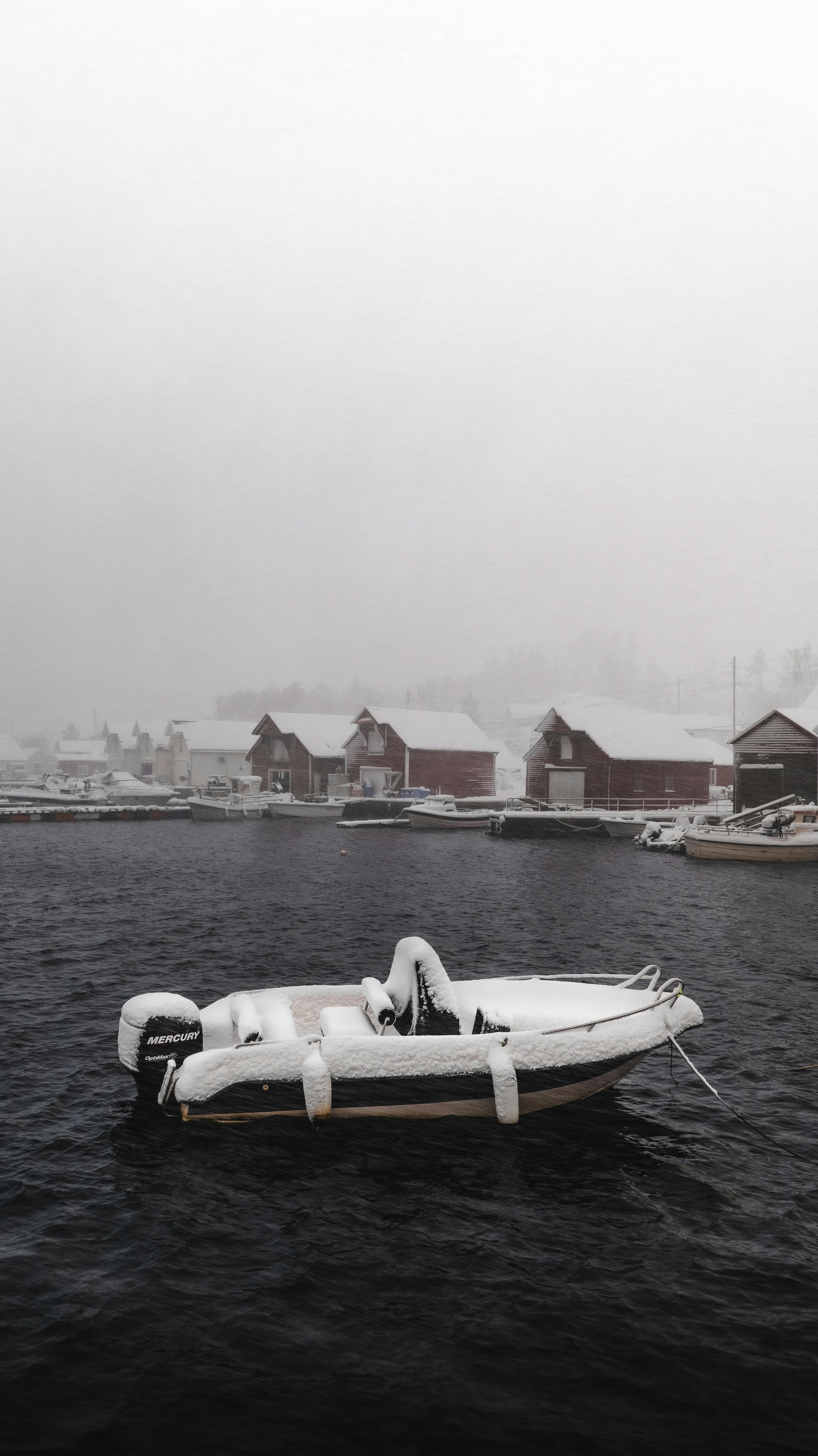 A Snow Covered Boat on the Sea · Free Stock Photo