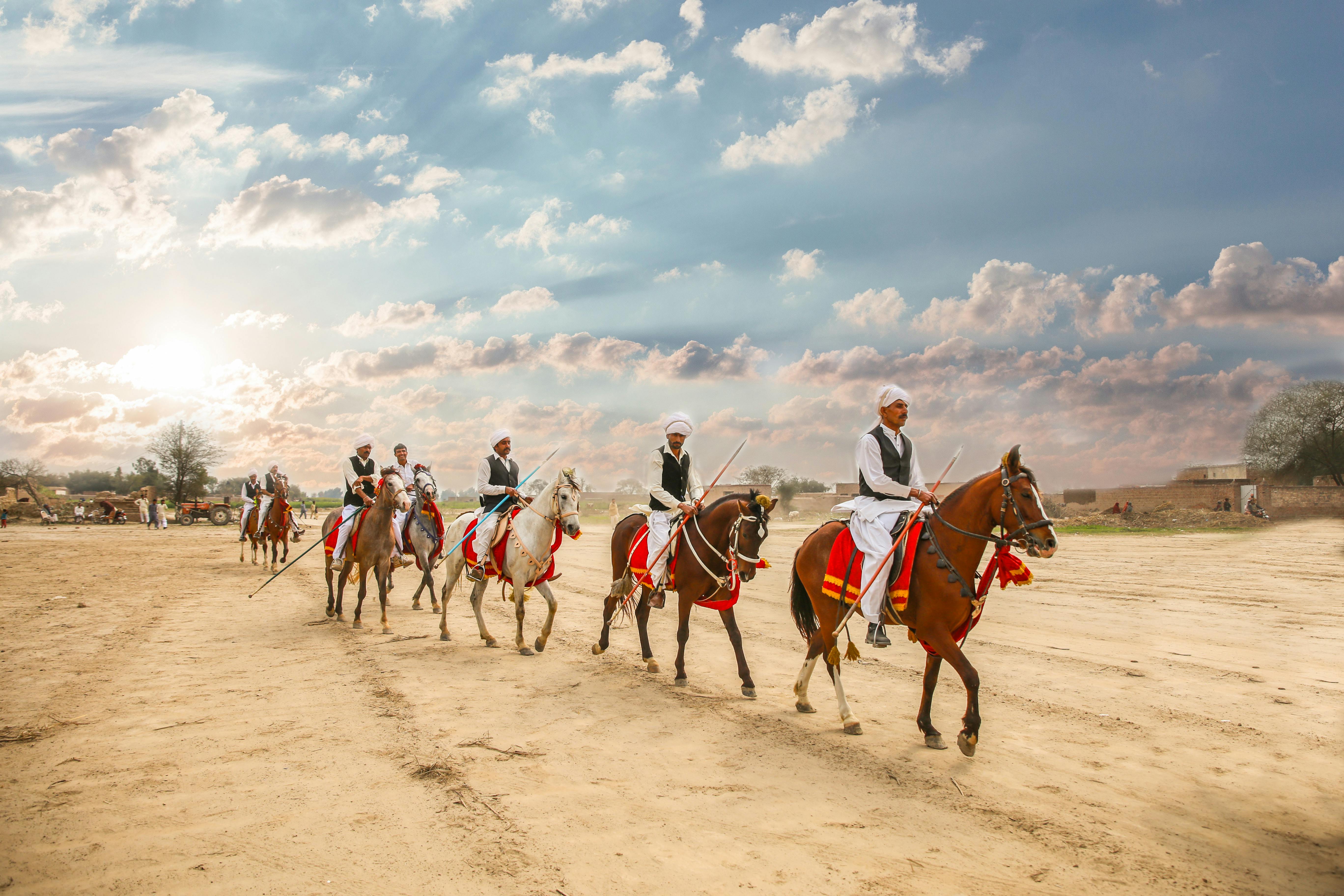 Person in Blue Dress Standing on 2 Horse Following 3 Horse during ...