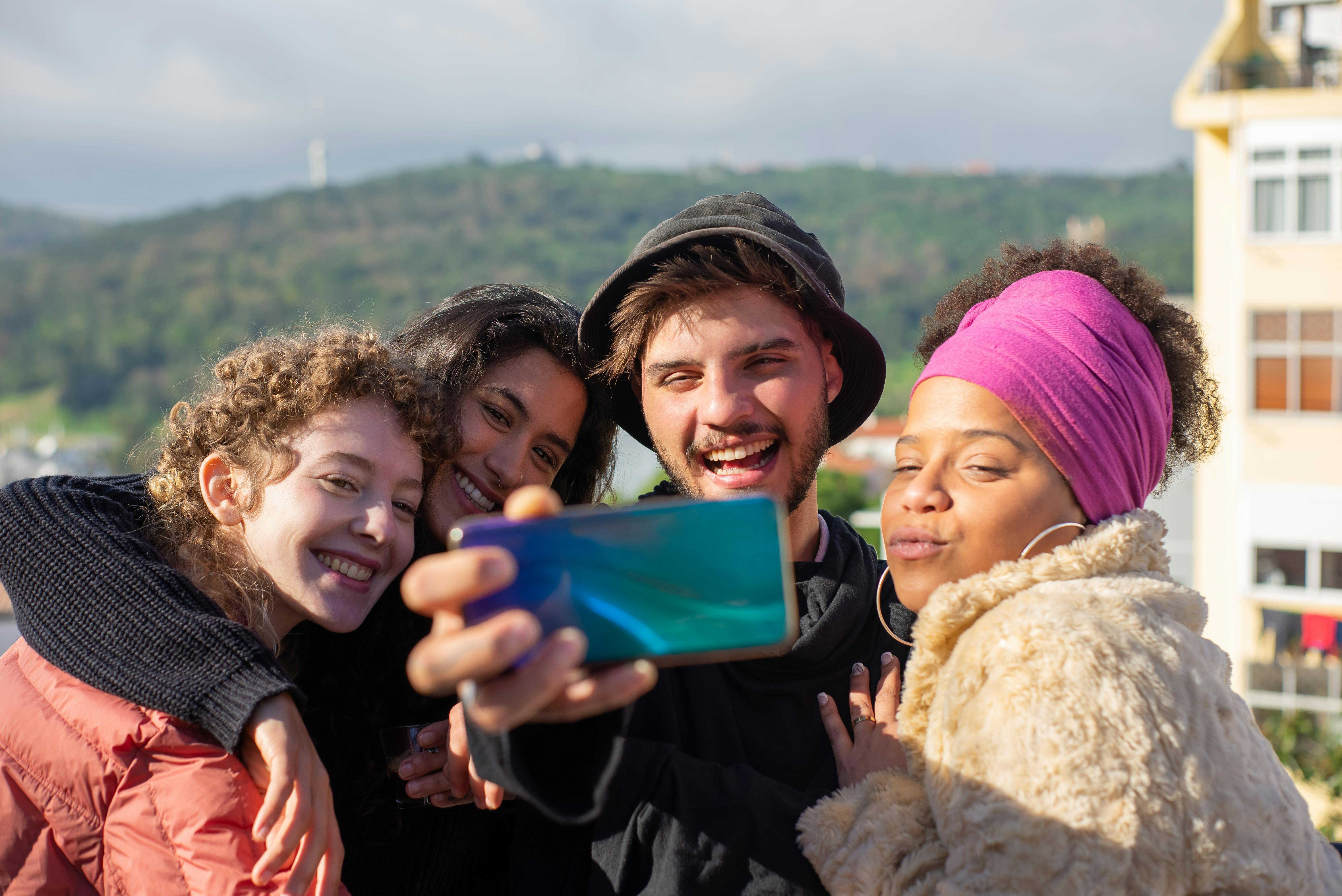A Group of Friends Using Their Smartphones · Free Stock Photo