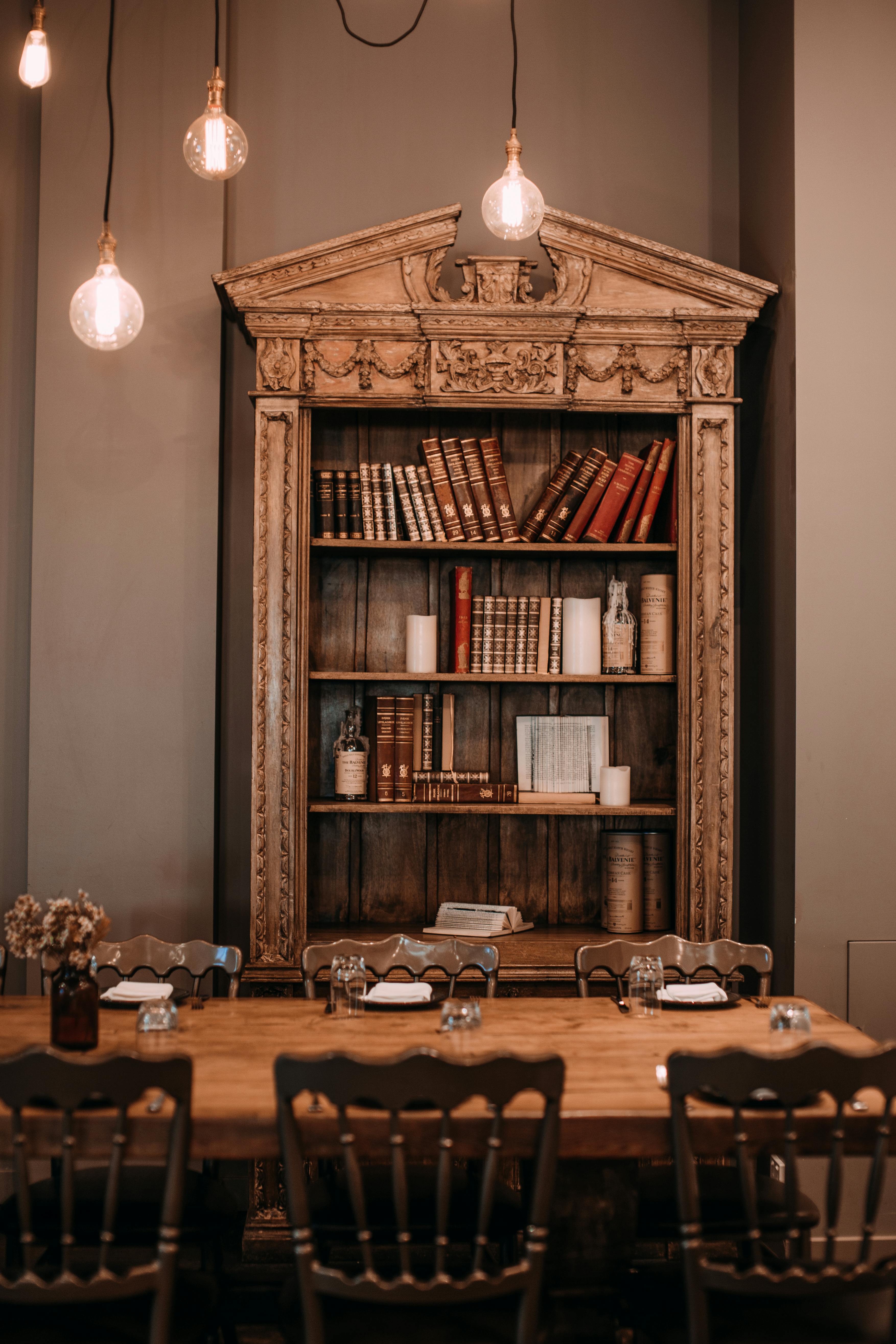 Bookcase Near a Table · Free Stock Photo