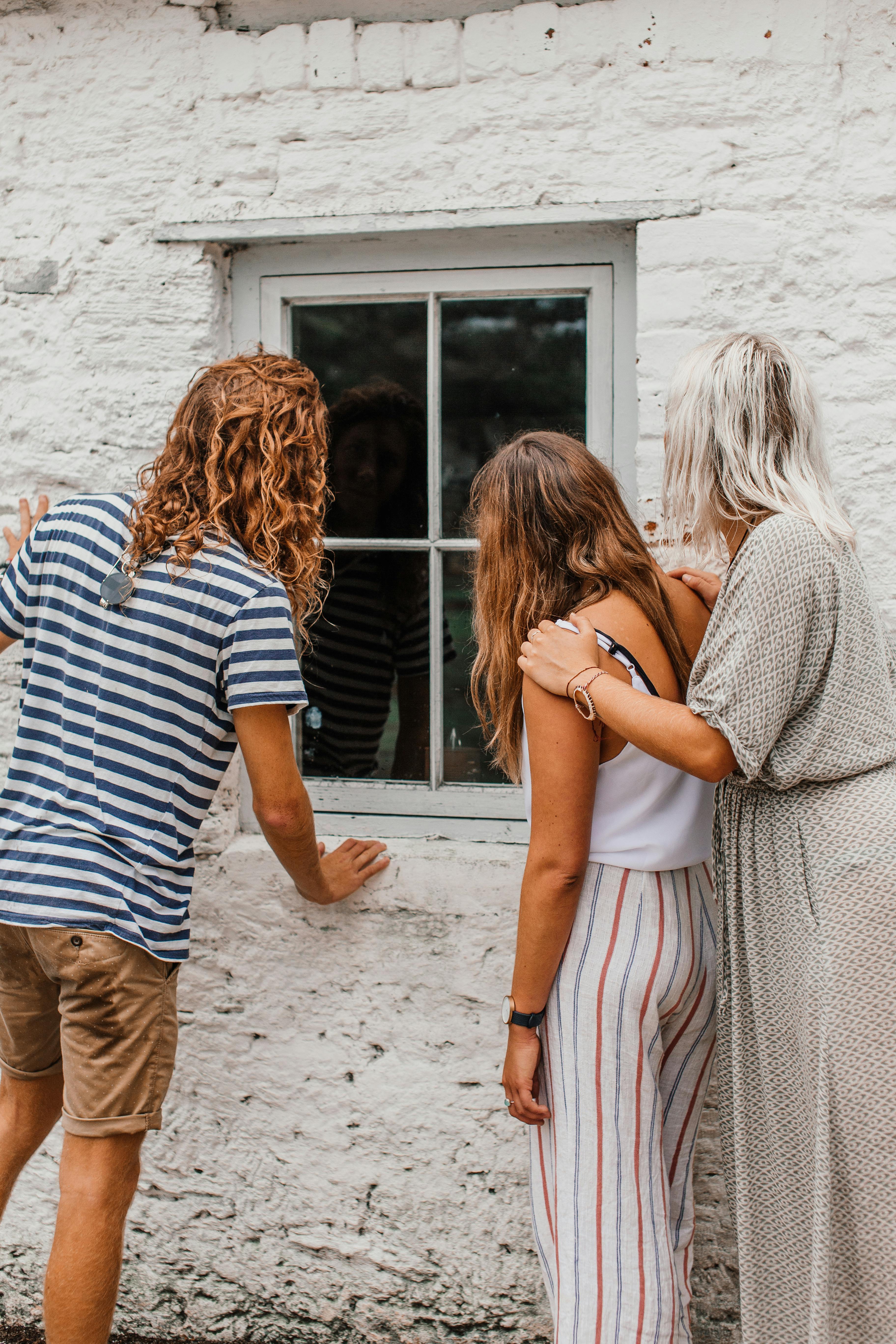 Women Looking inside a House Through a Window · Free Stock Photo