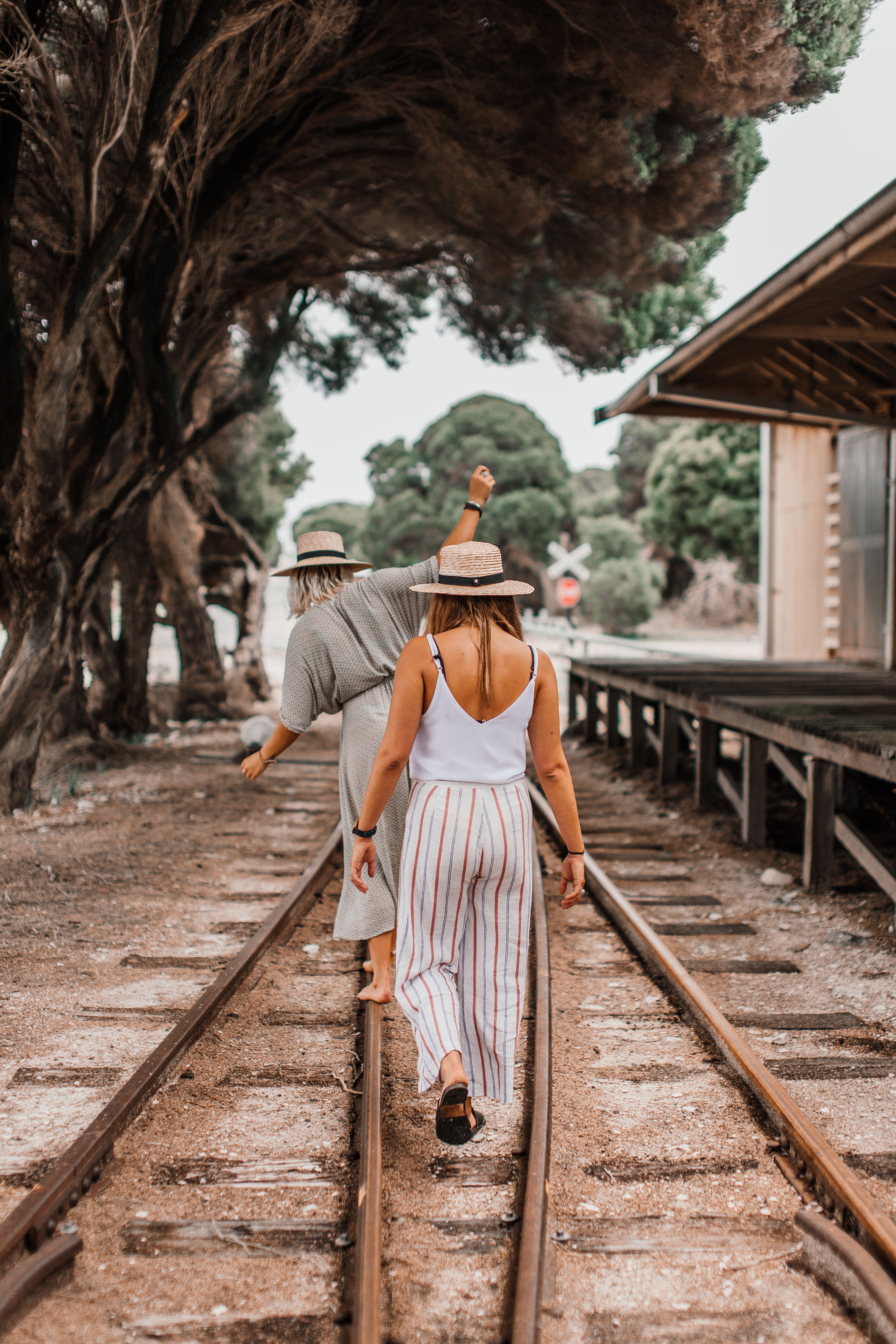 Man and Woman Walking on Train Rail · Free Stock Photo