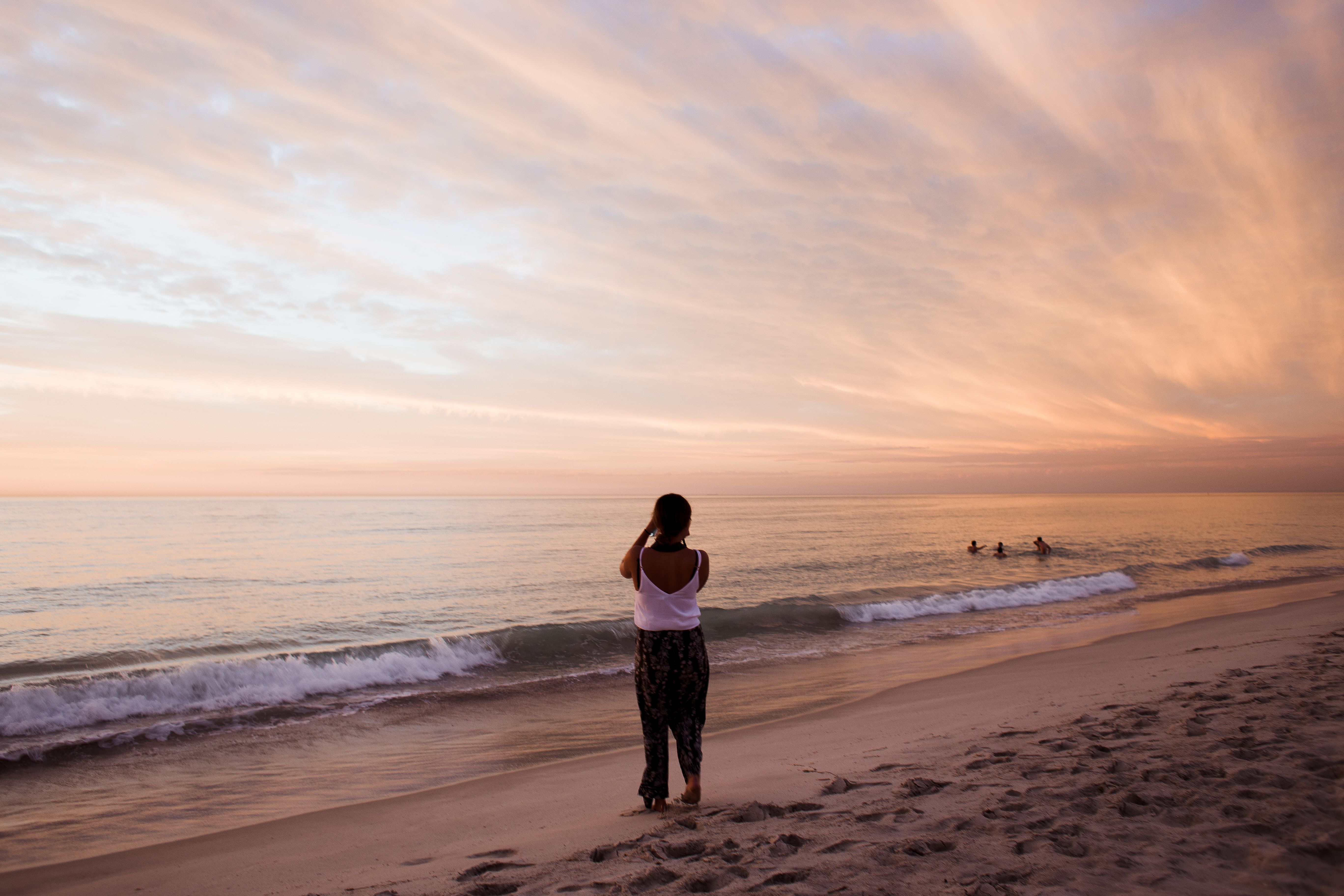 Woman on a Beach at Sunset · Free Stock Photo