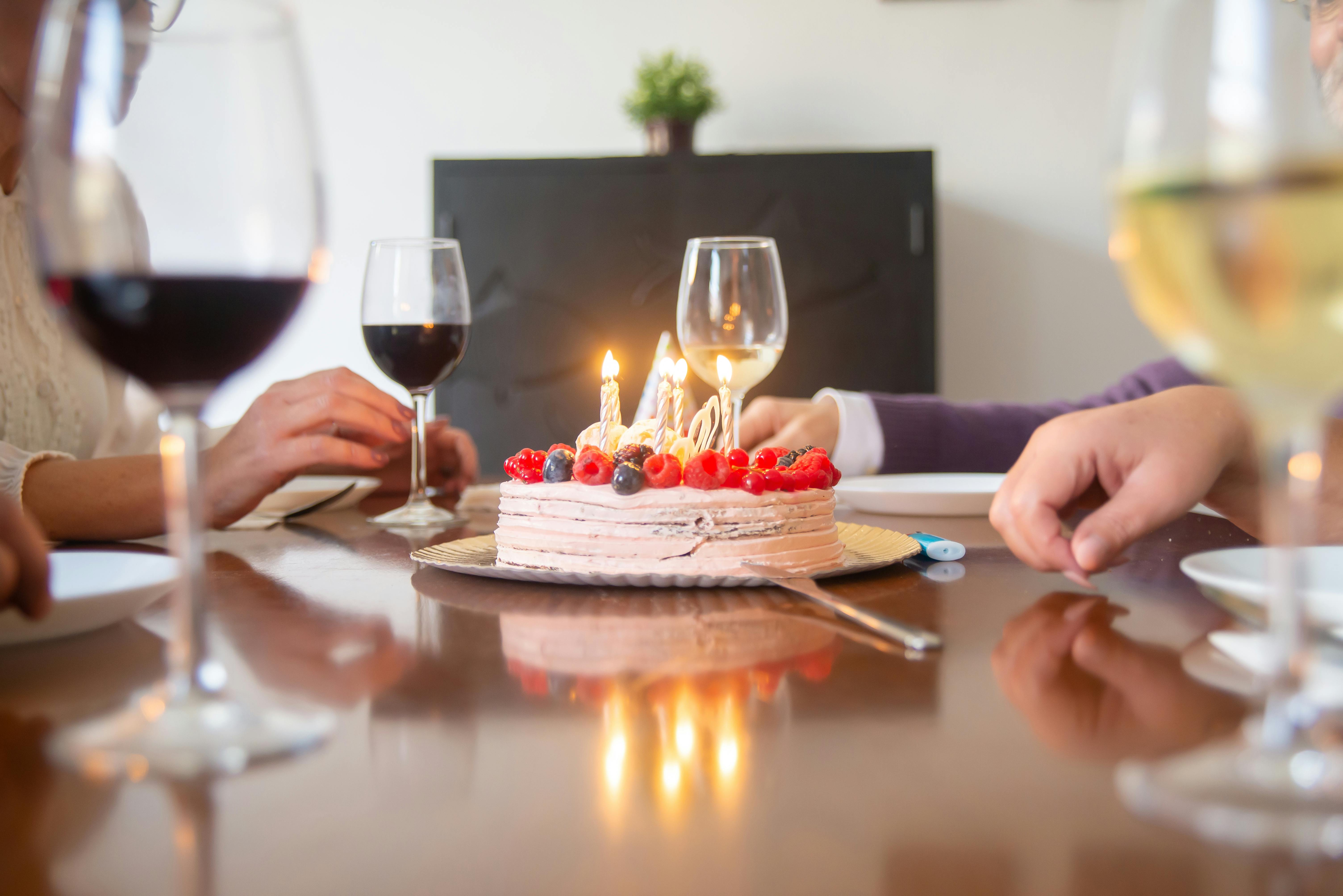 People Sitting at Table with Birthday Cake · Free Stock Photo
