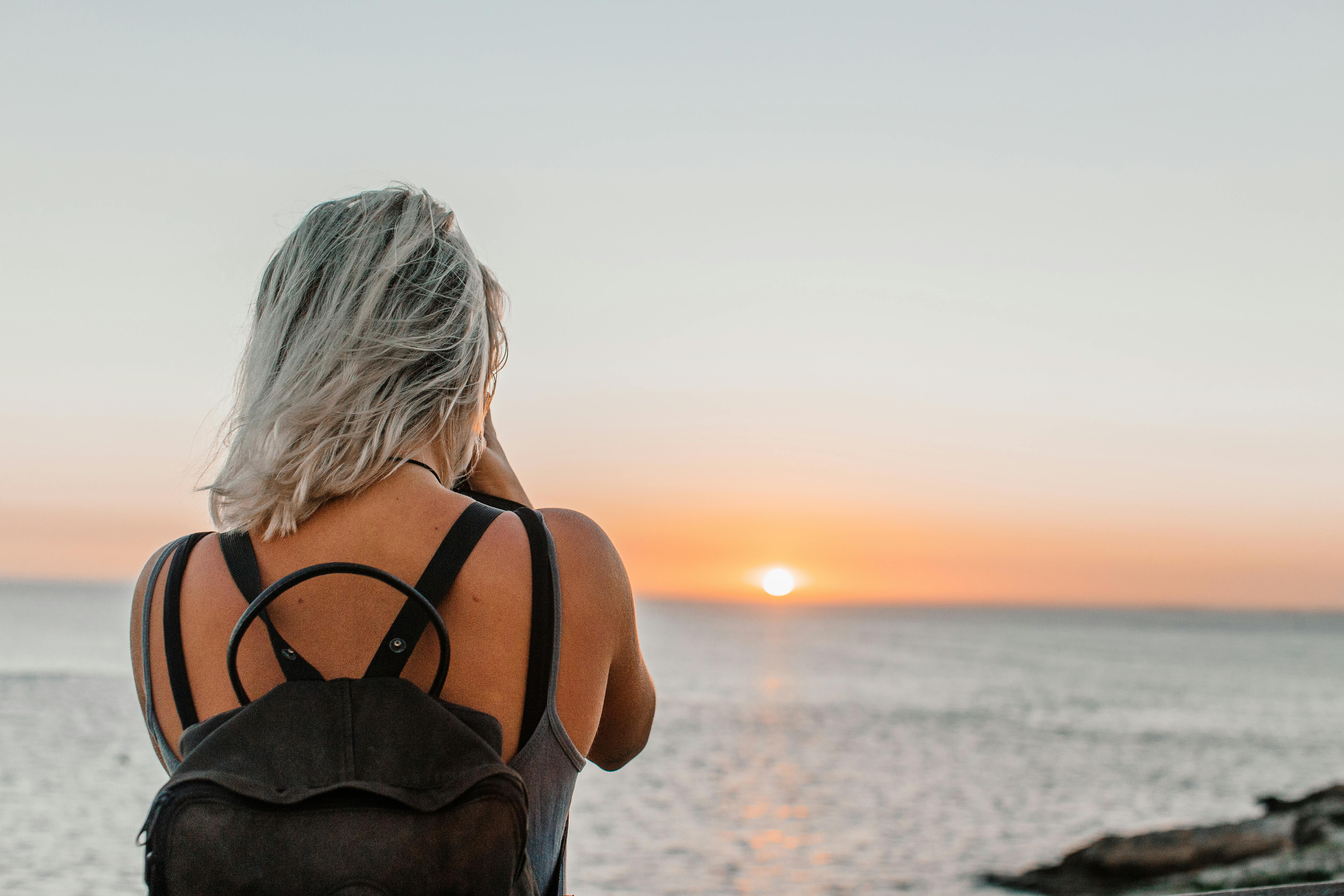 Woman on Sea Shore at Sunset · Free Stock Photo