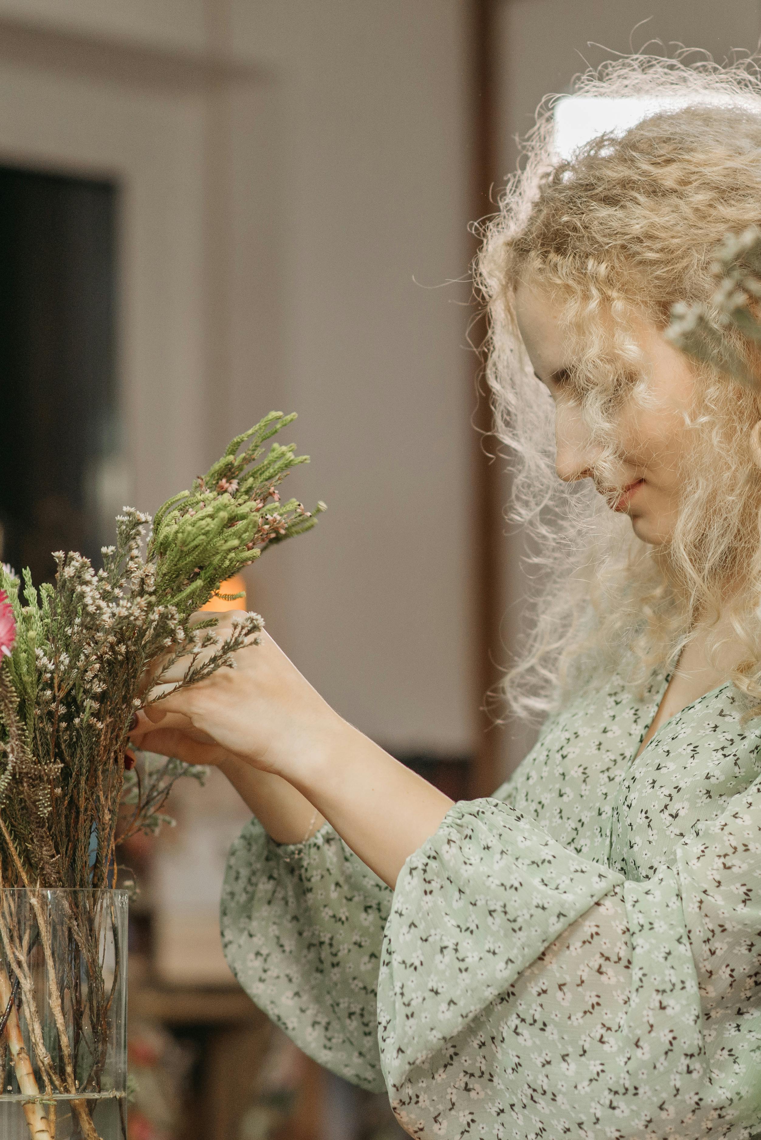 Woman Fixing Plants in Vase · Free Stock Photo