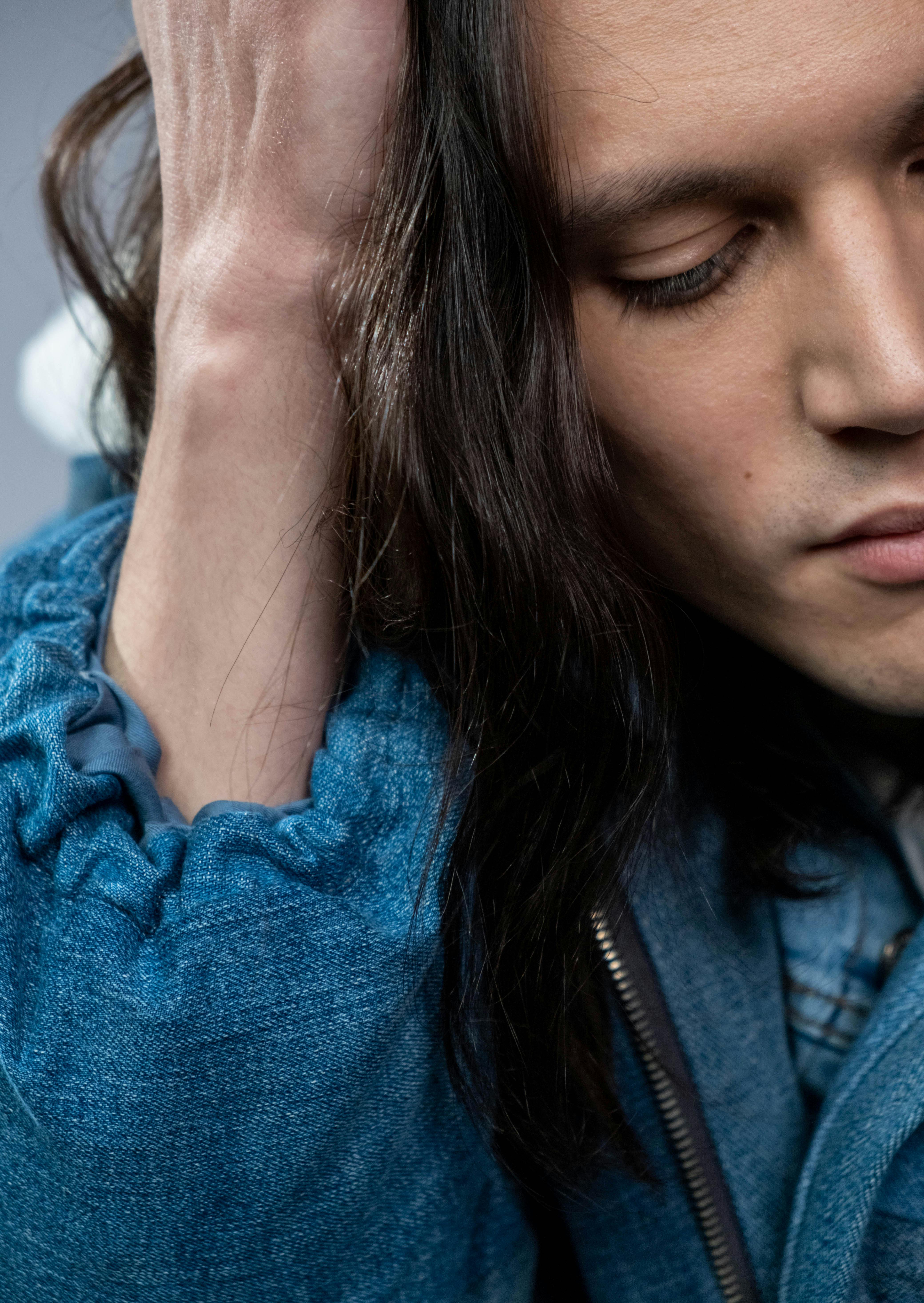 Close-up Shot of a Person holding his Head · Free Stock Photo