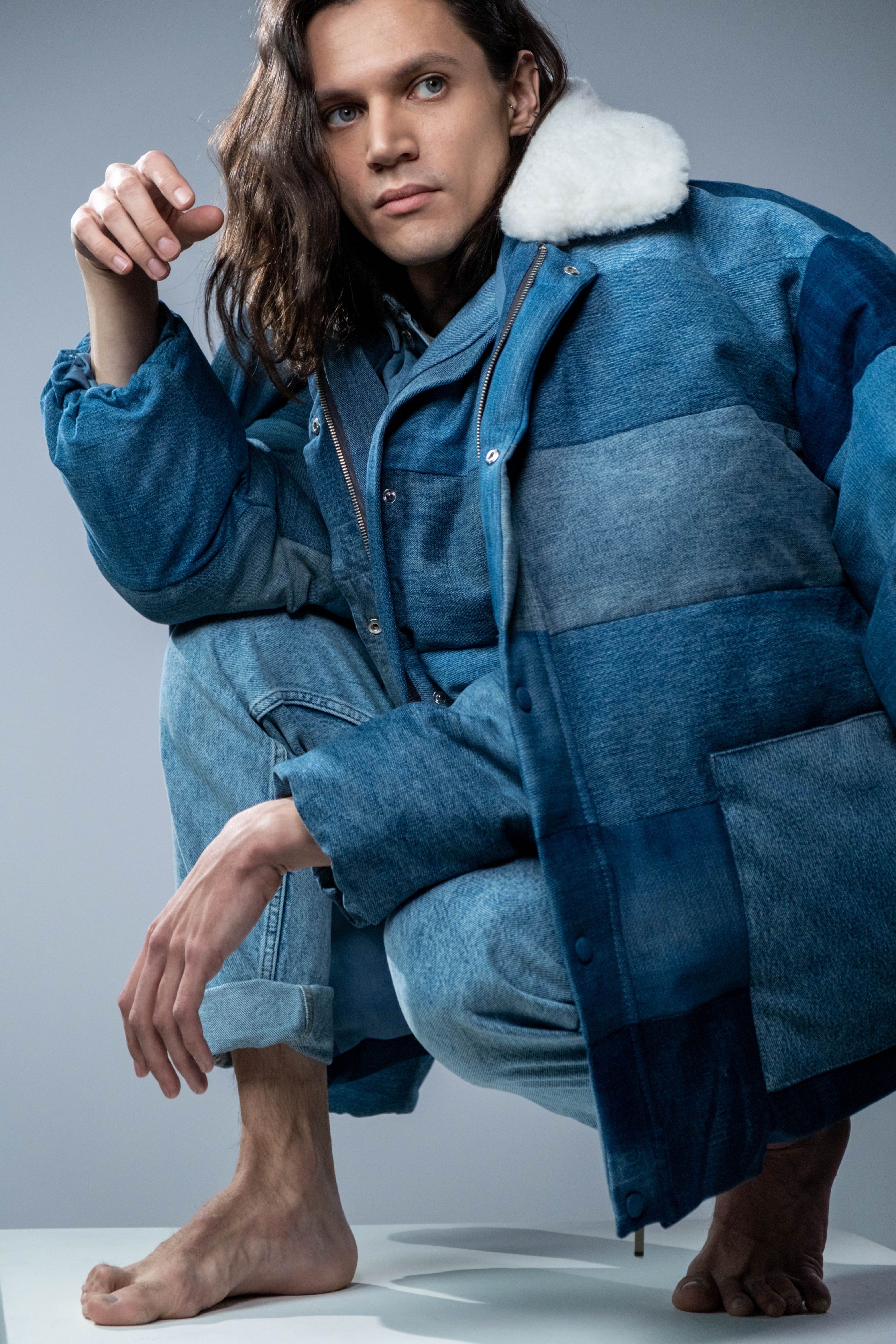 Barefoot Man Crouch in Warm Jacket · Free Stock Photo