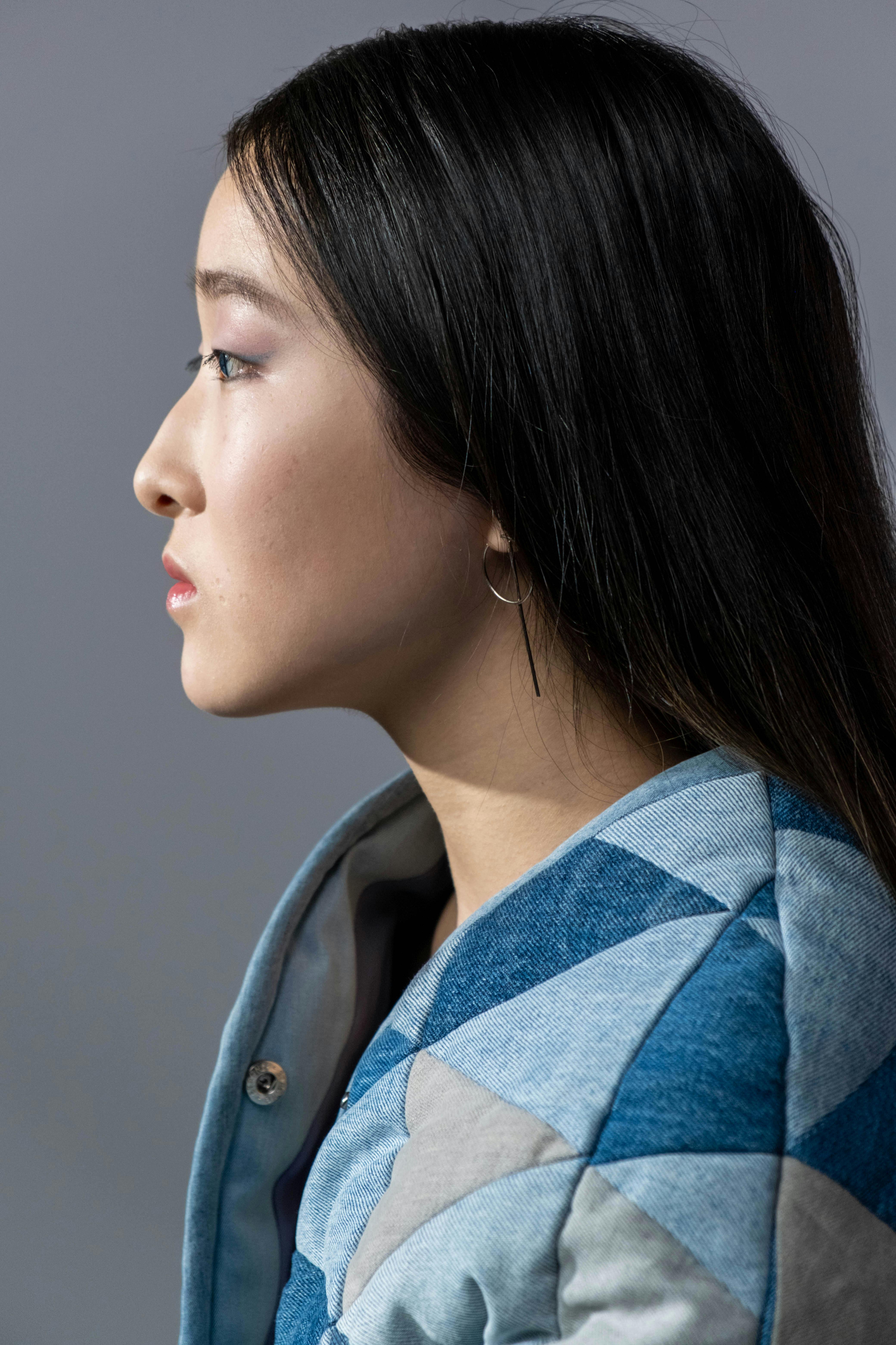 A Side View of a Woman in a Patterned Jacket · Free Stock Photo