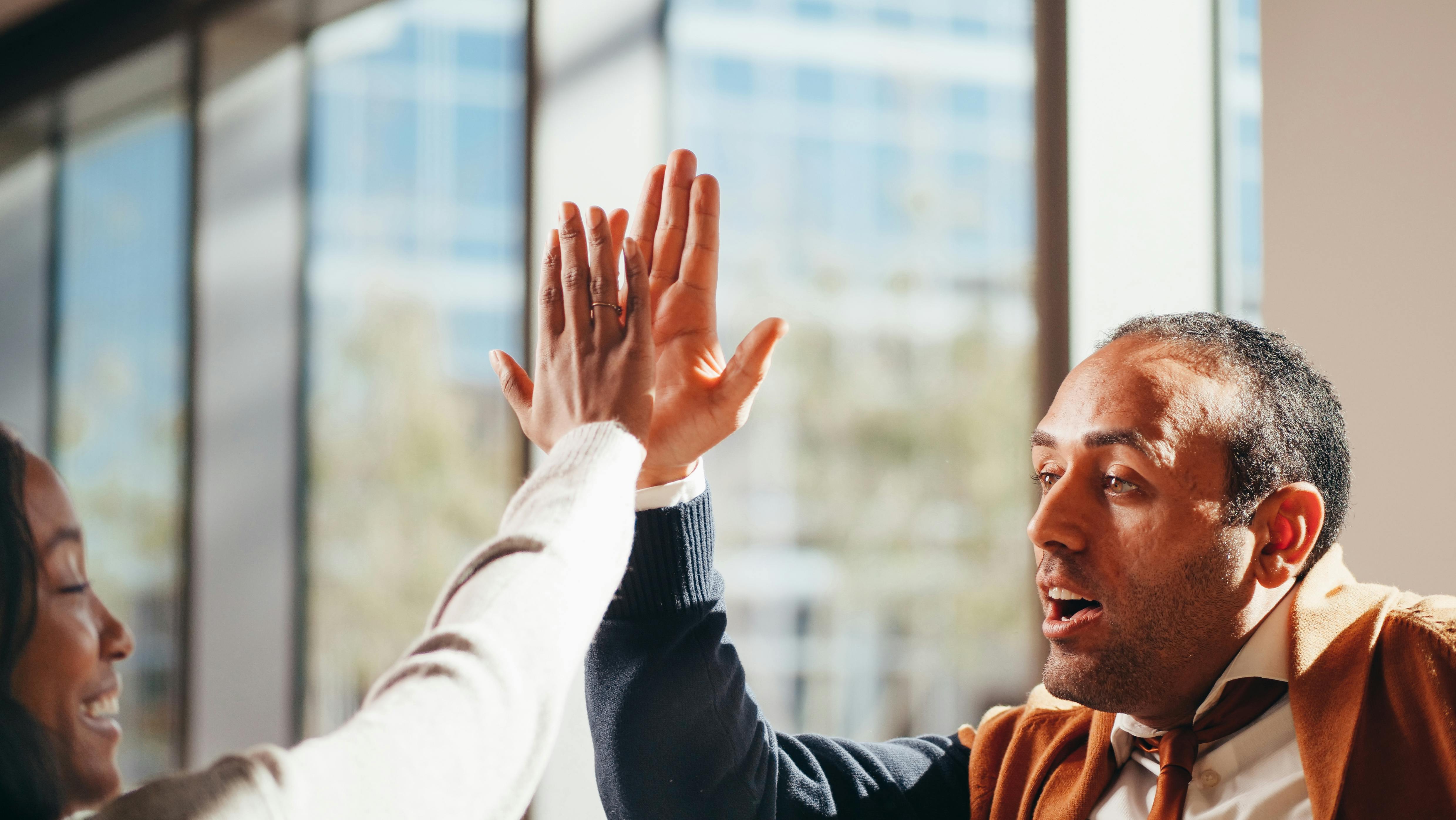 Man and Woman Doing High Five · Free Stock Photo