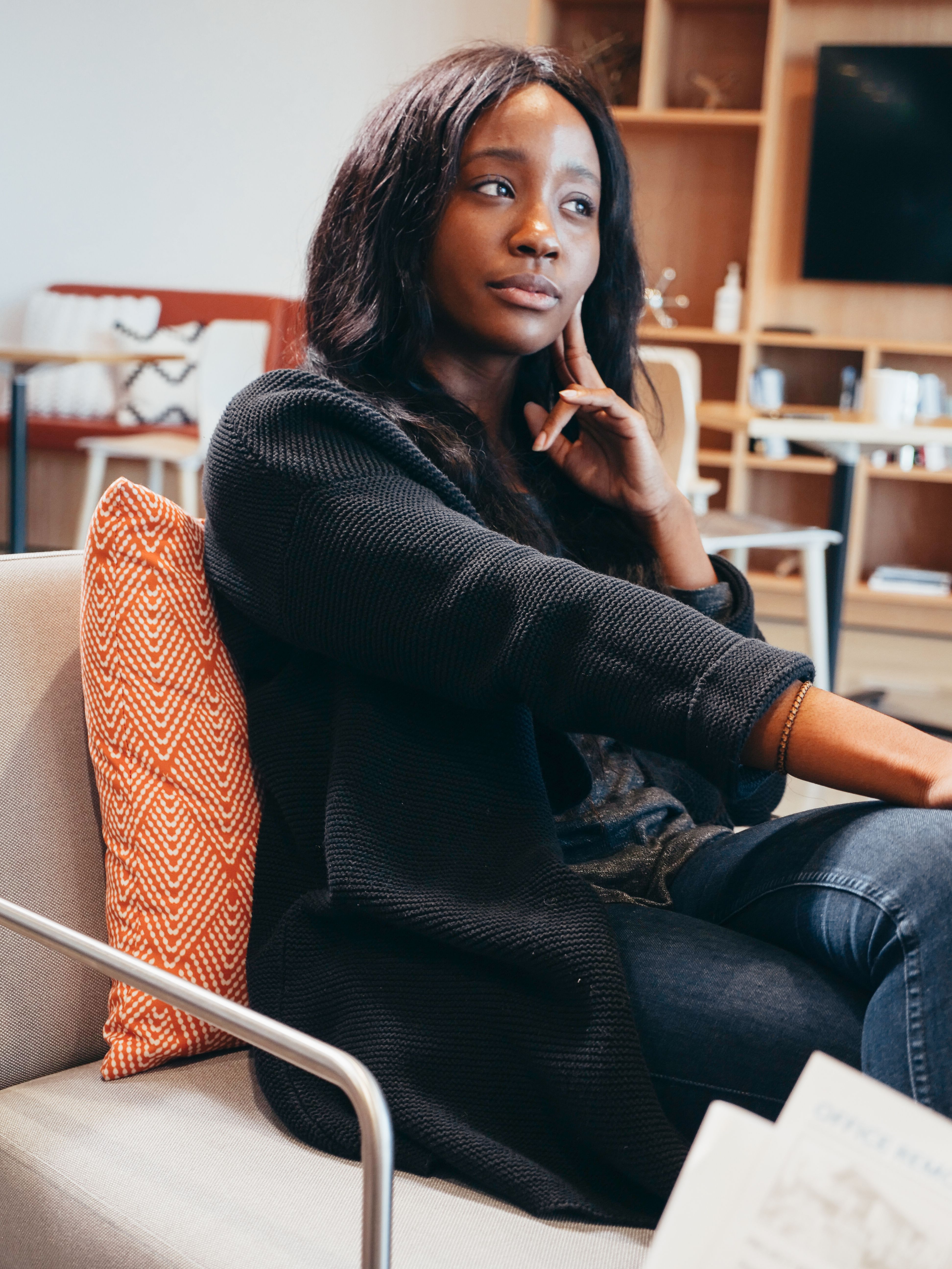 A Woman Sitting on the Chair while Thinking · Free Stock Photo