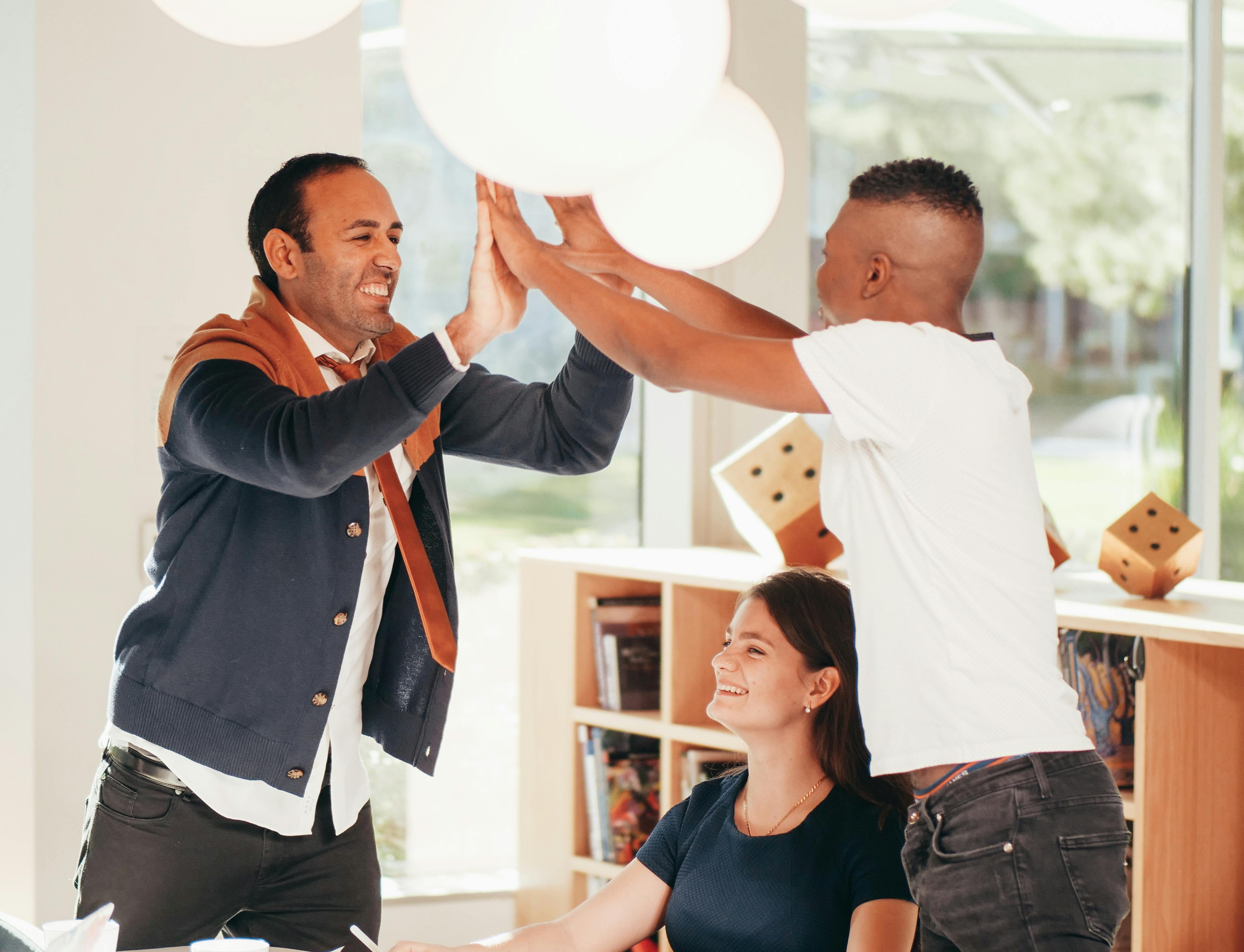 Two Men Doing a High Ten Hand Gesture · Free Stock Photo