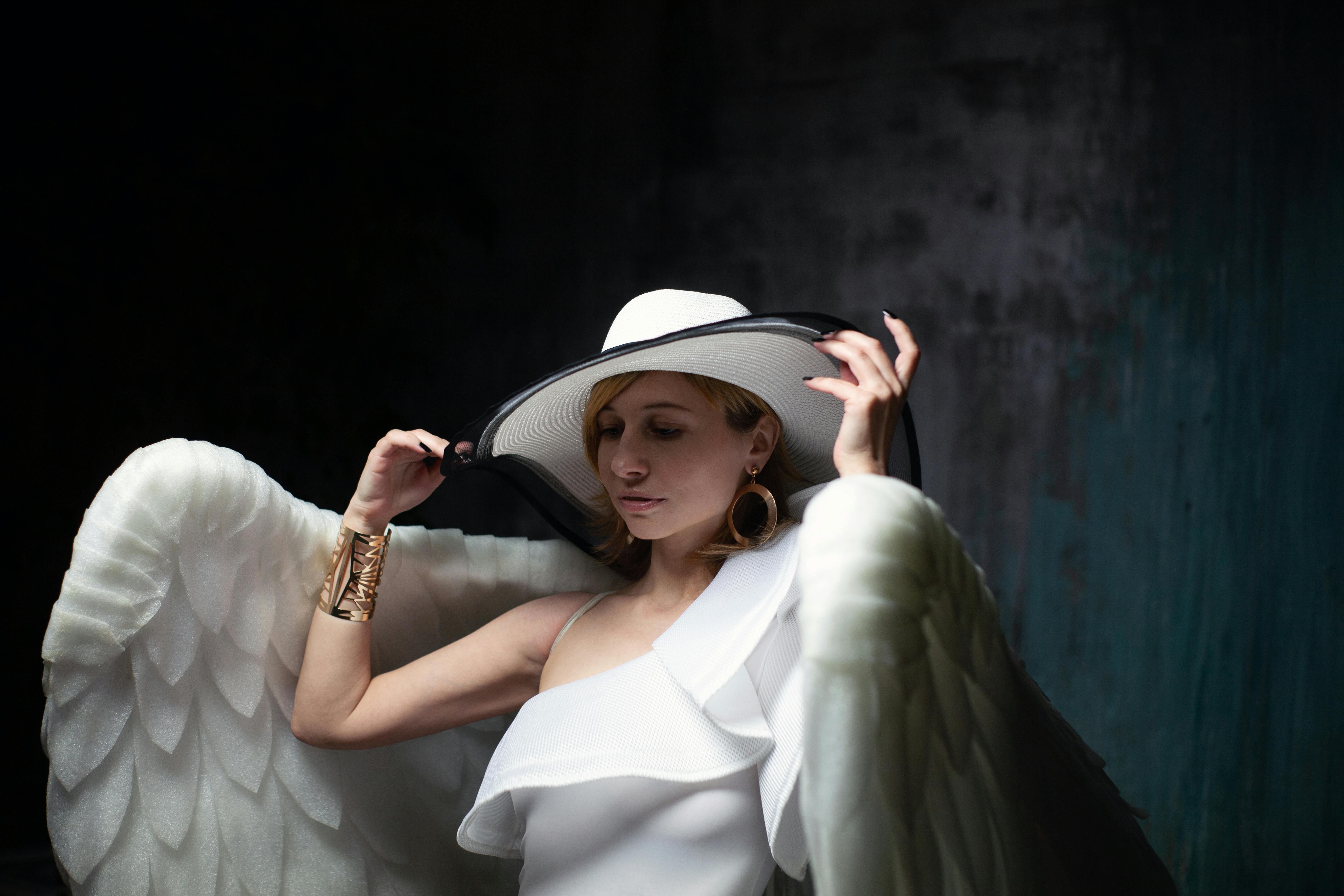 Graceful model with angel wings on dark background · Free Stock Photo