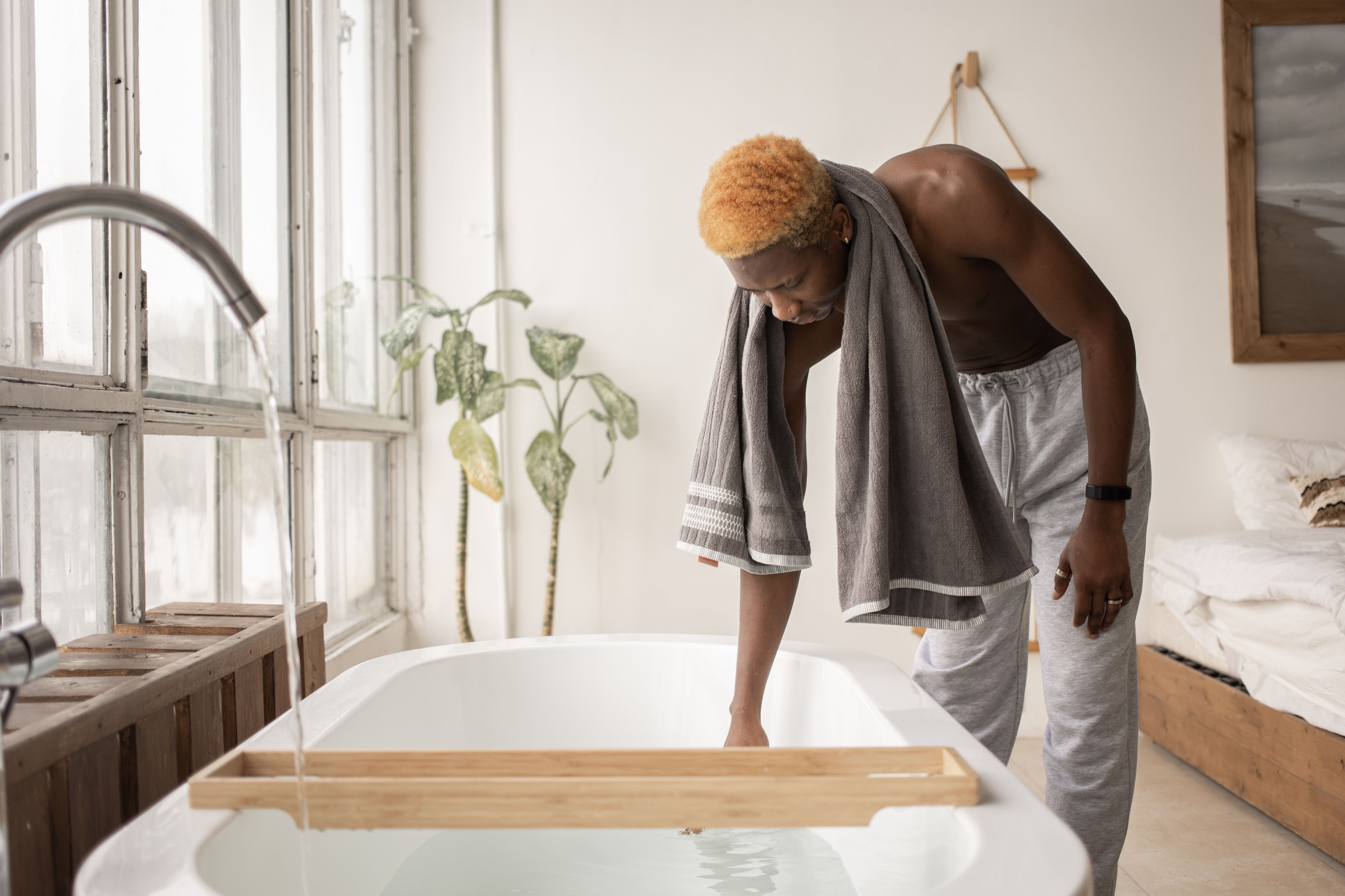 A Man Standing Near the Bathtub · Free Stock Photo