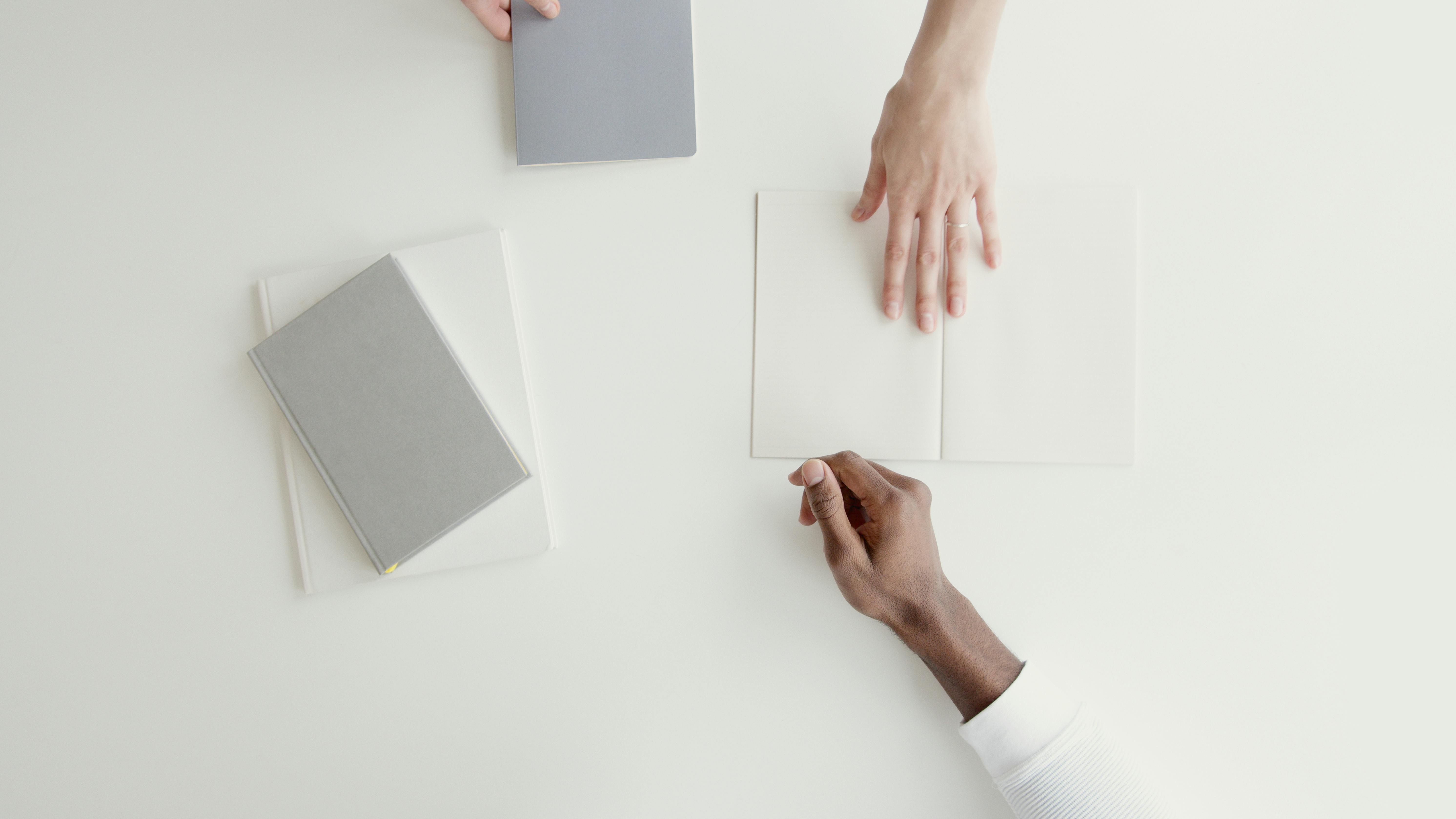 Person Handing A White Paper To Another Person · Free Stock Photo