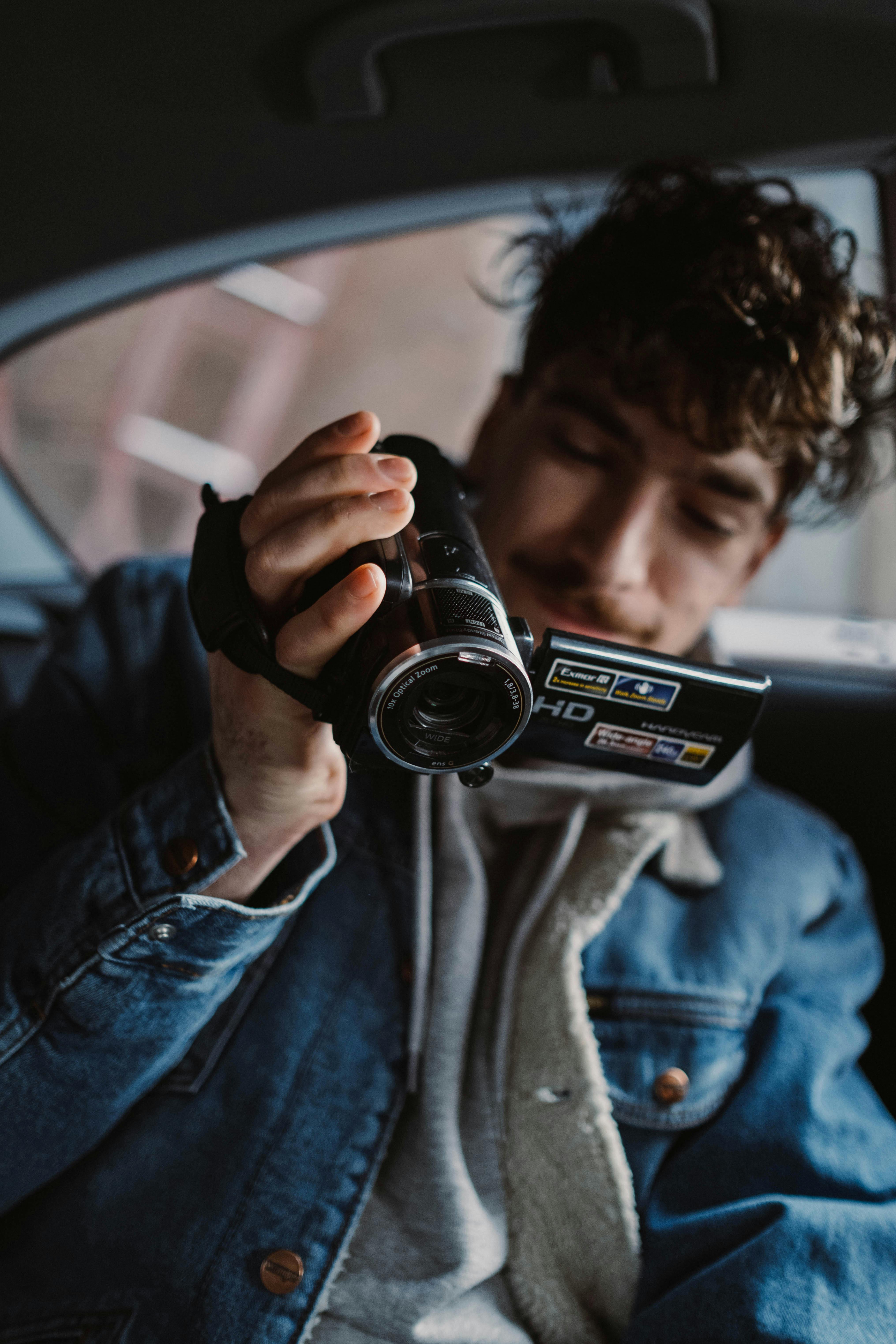Man with Video Camera in Car · Free Stock Photo