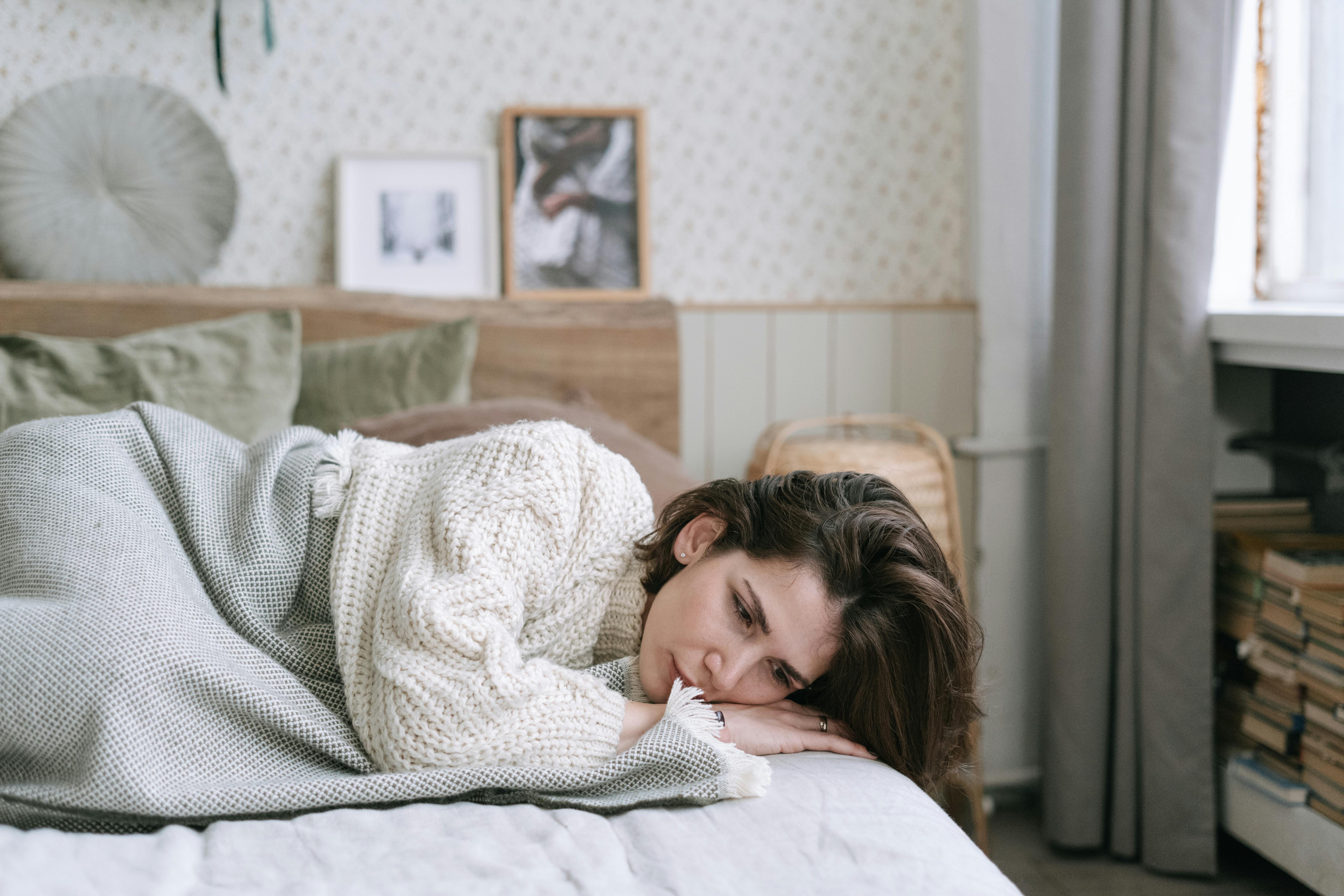 A Woman Lying Down on a Bed · Free Stock Photo
