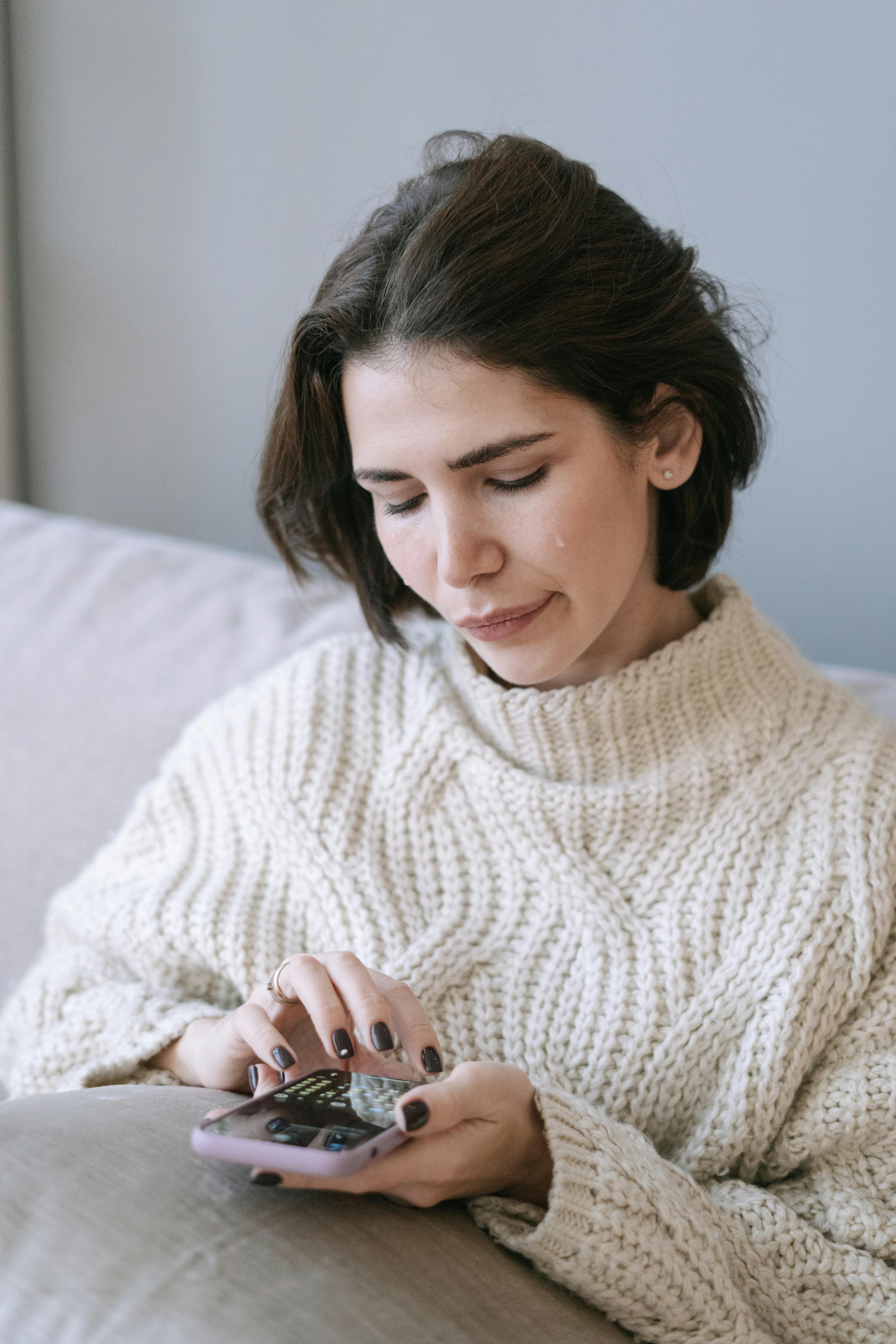 A Woman Crying While Using Her Phone · Free Stock Photo