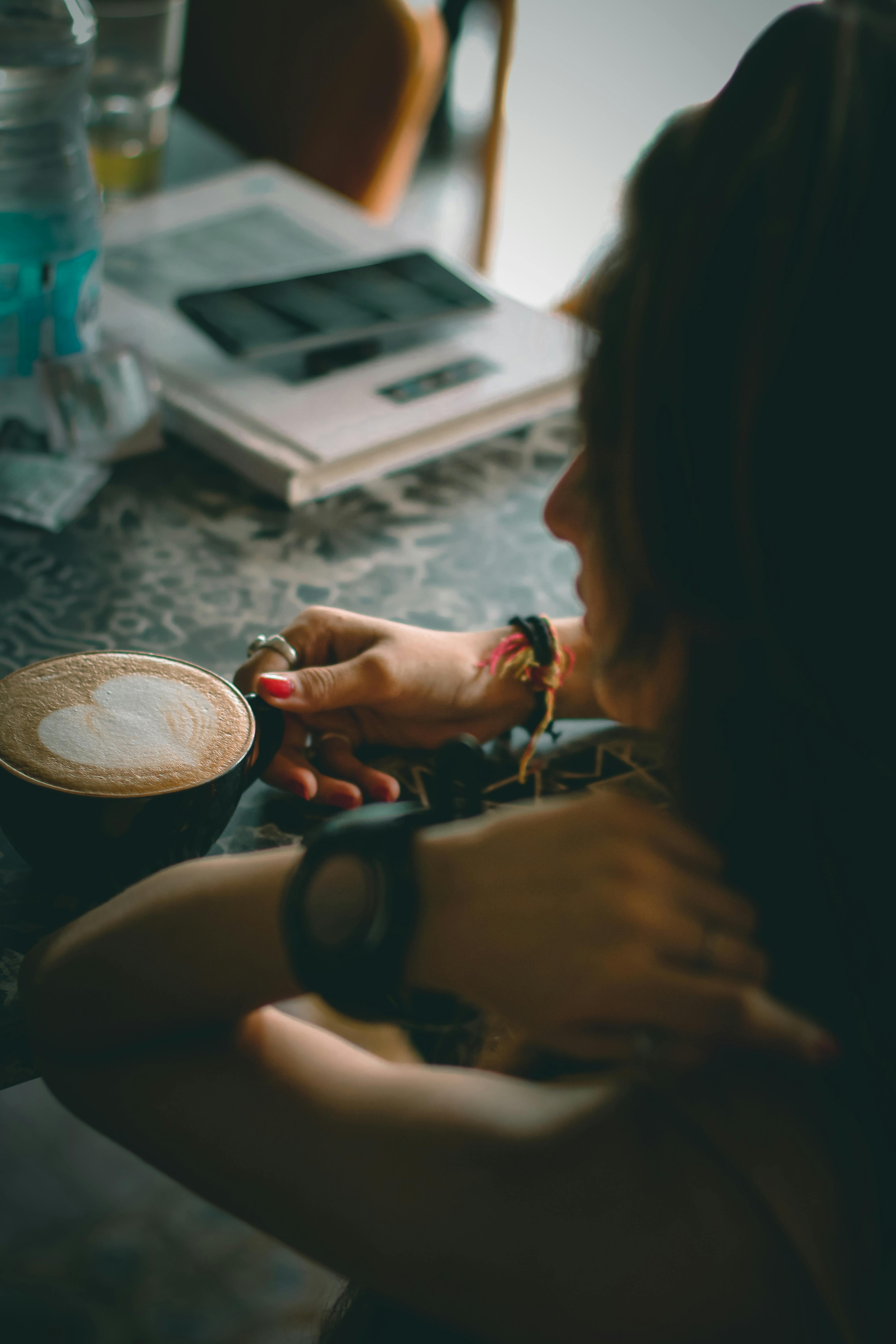 Person Pouring Hot Liquid on Ceramic Cup · Free Stock Photo