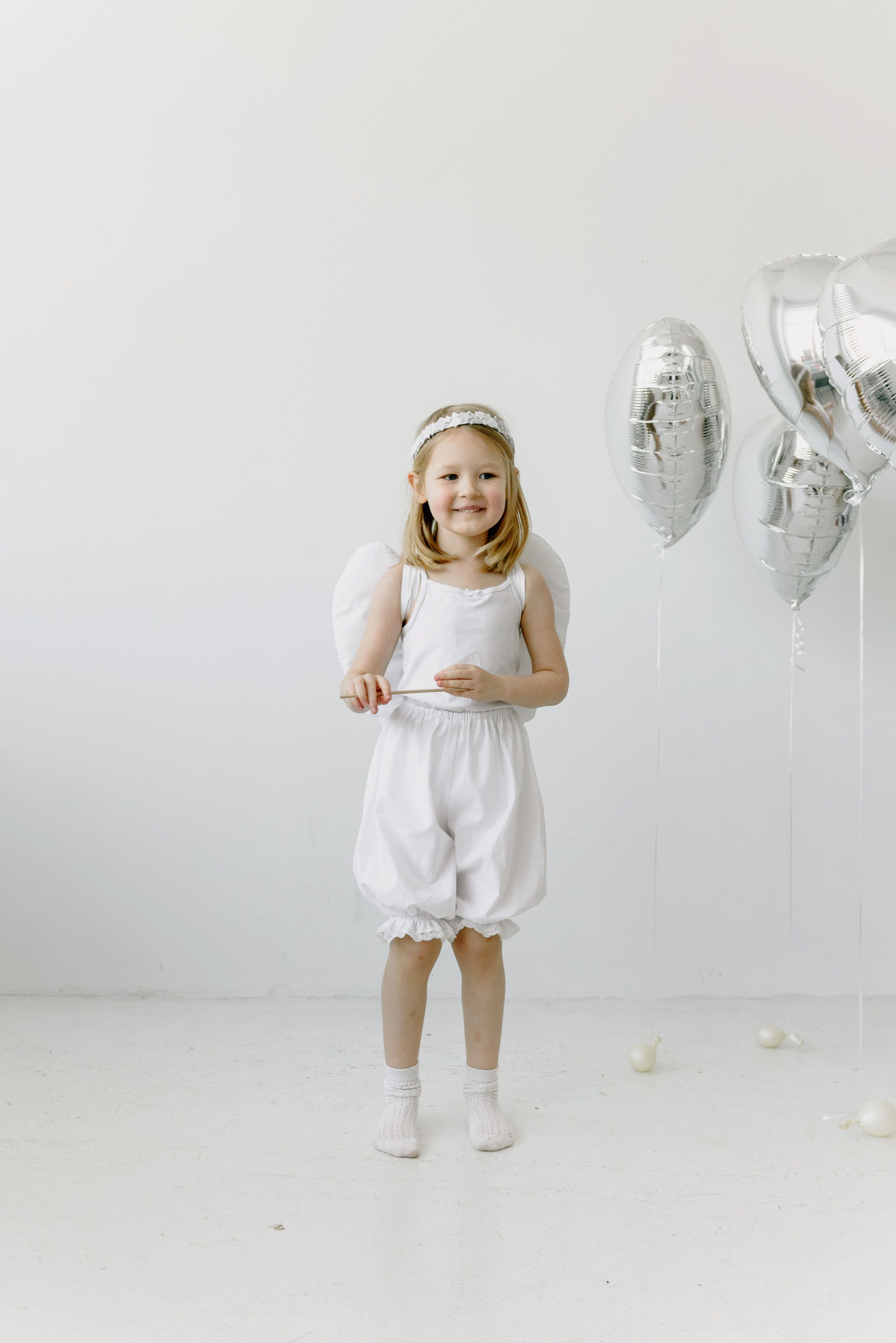 Young Girl Wearing an Angel Costume Smiling · Free Stock Photo