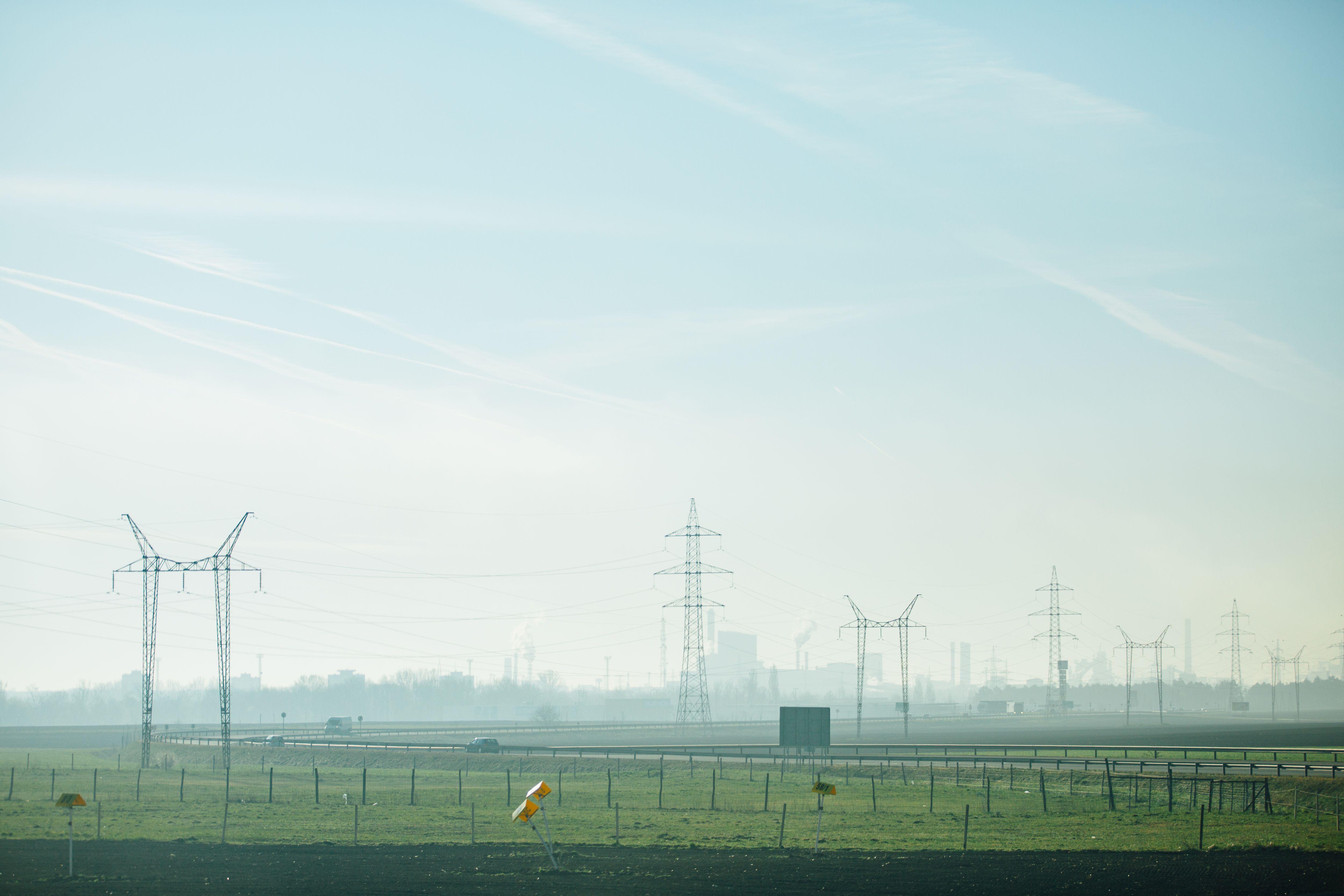 A Foggy Field with Electric Towers · Free Stock Photo
