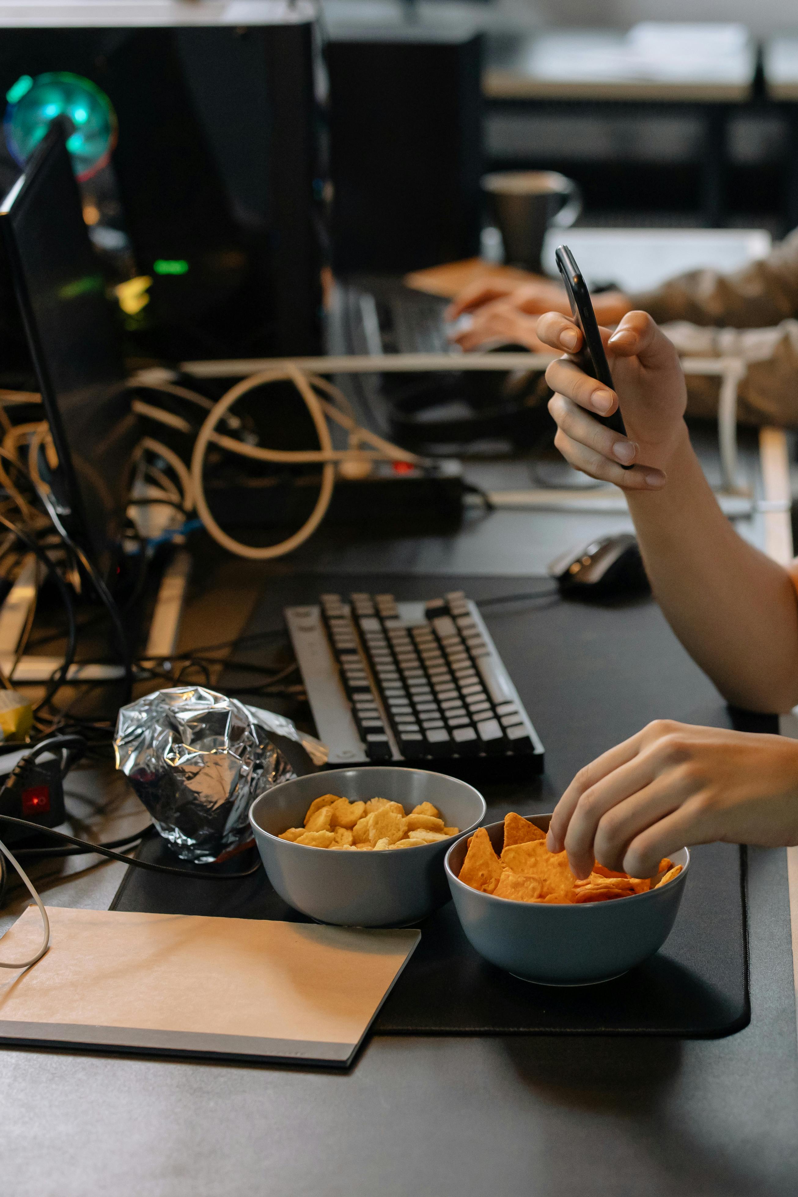 Eating and Texting Snacks at the Computer · Free Stock Photo