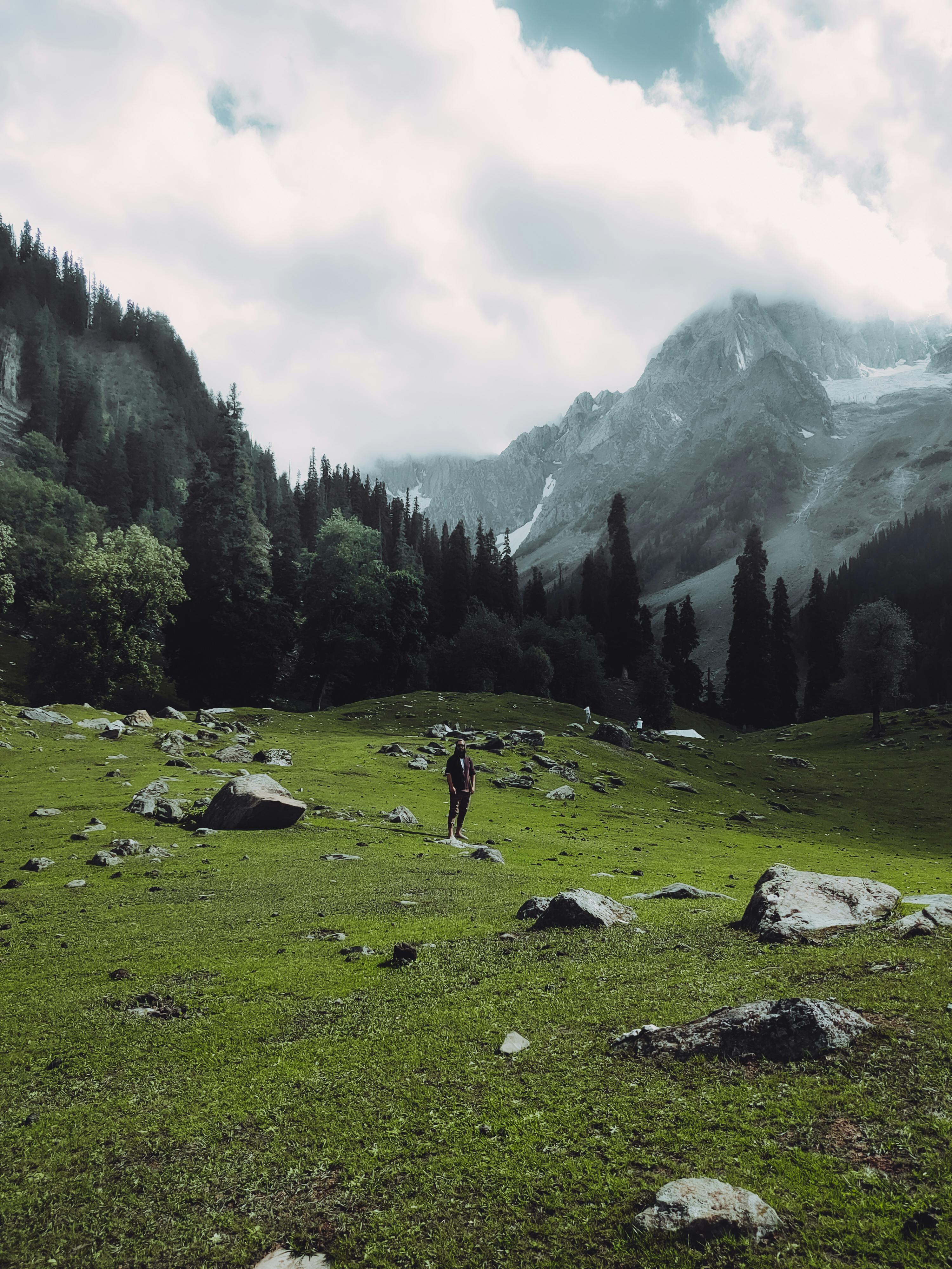 Person Standing on Stone in Mountain Landscape · Free Stock Photo