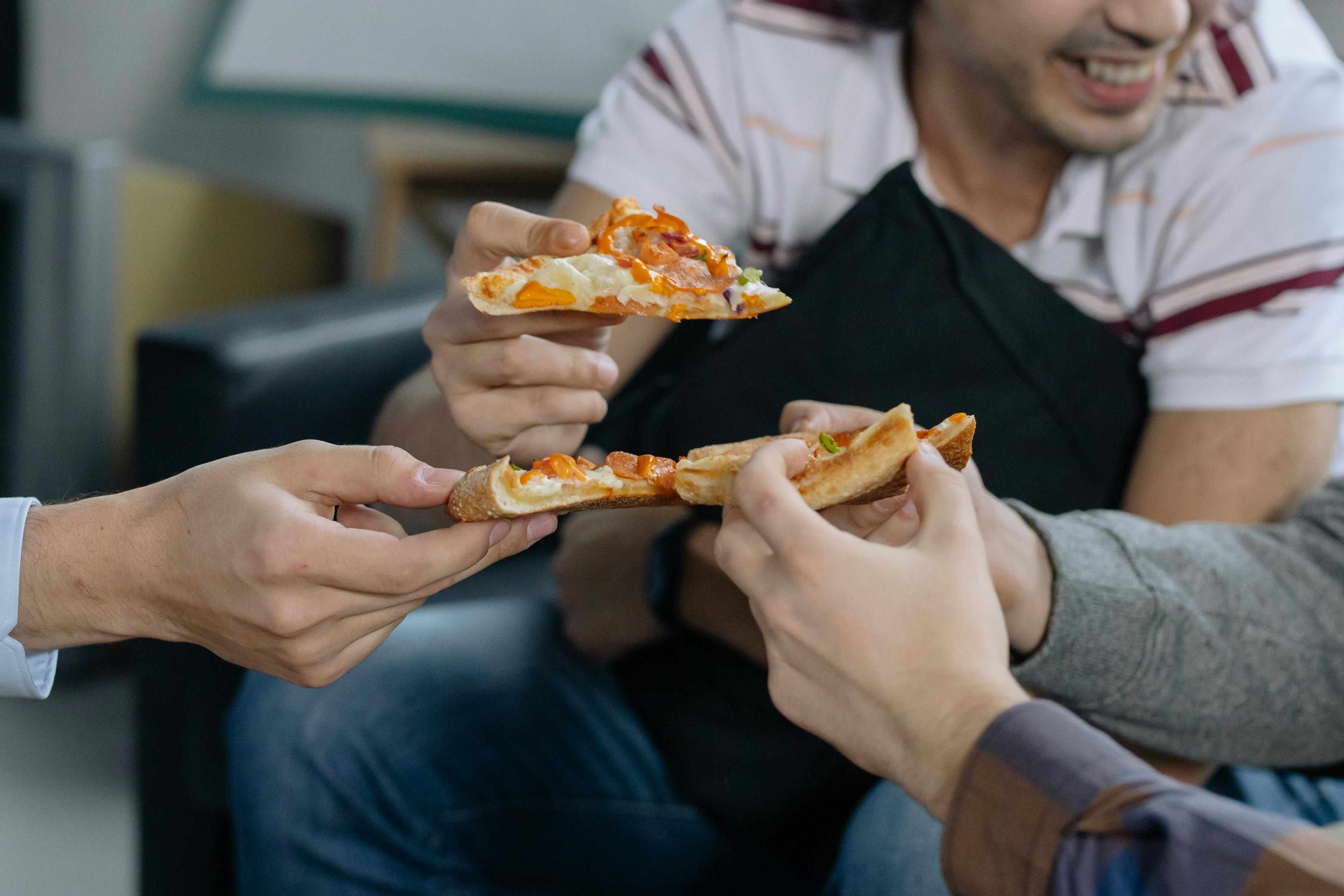 People Sharing a Pizza · Free Stock Photo