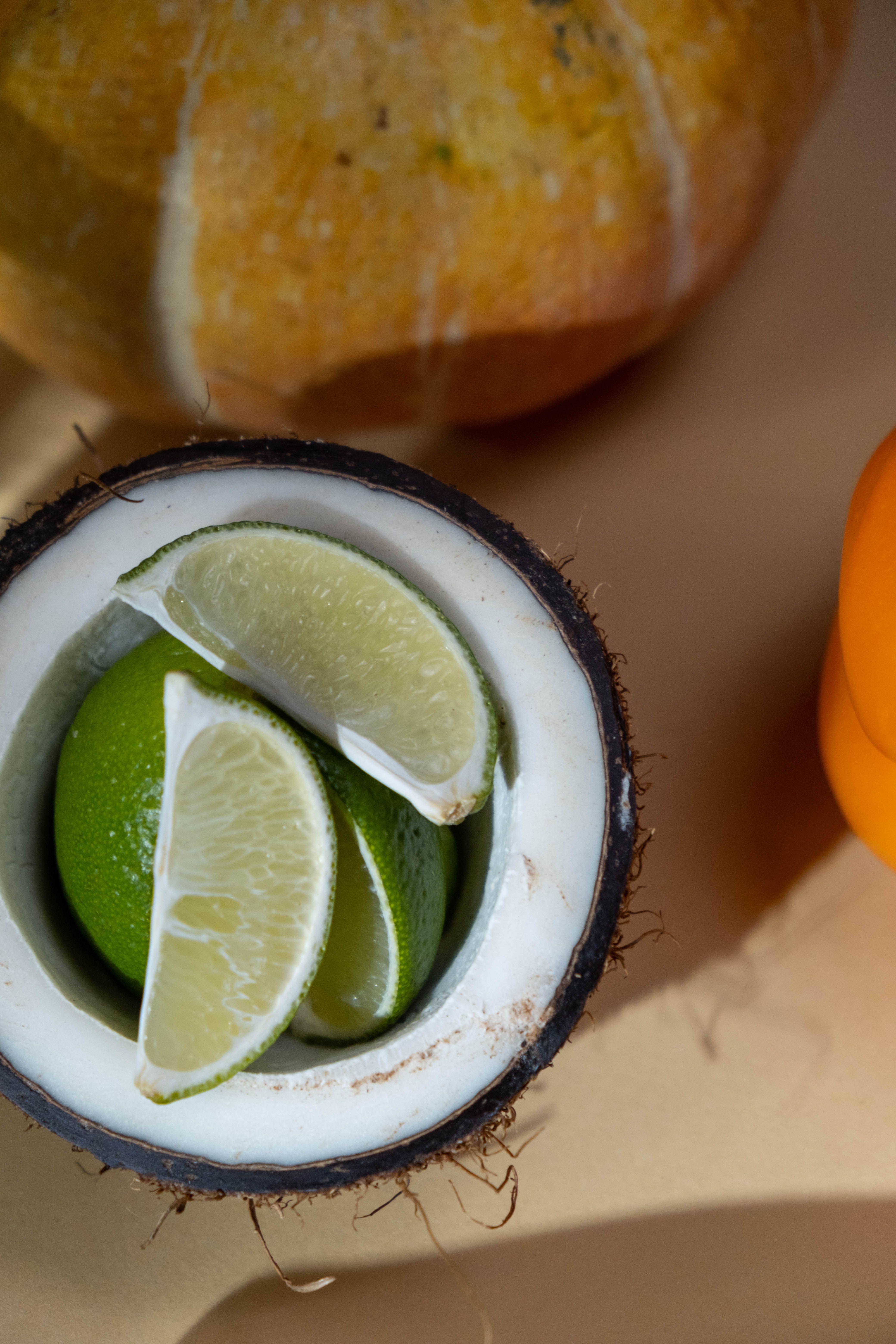 Lime Slices on a Coconut Shell · Free Stock Photo