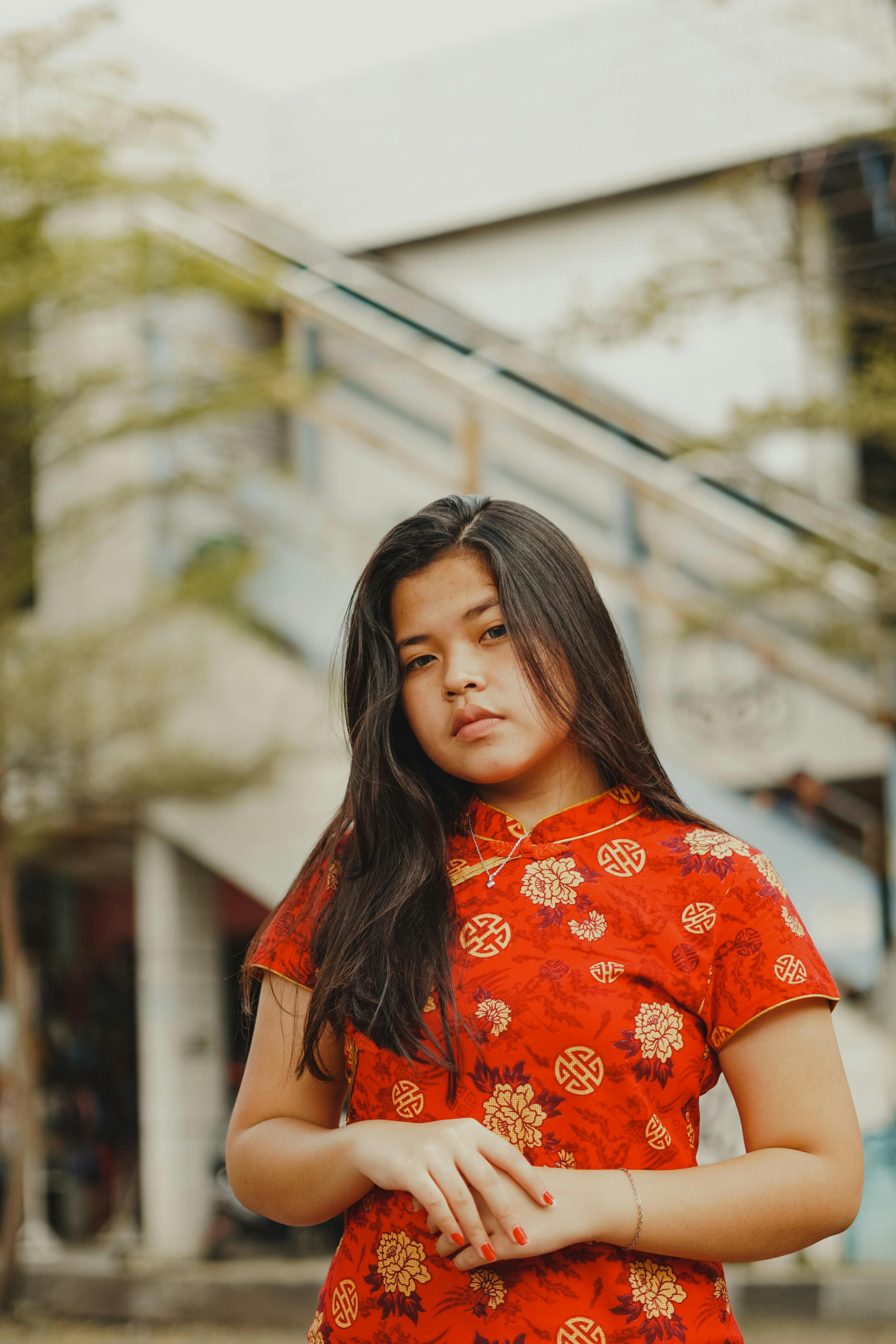 Teenage Girl Standing Beside Clothing Rack · Free Stock Photo