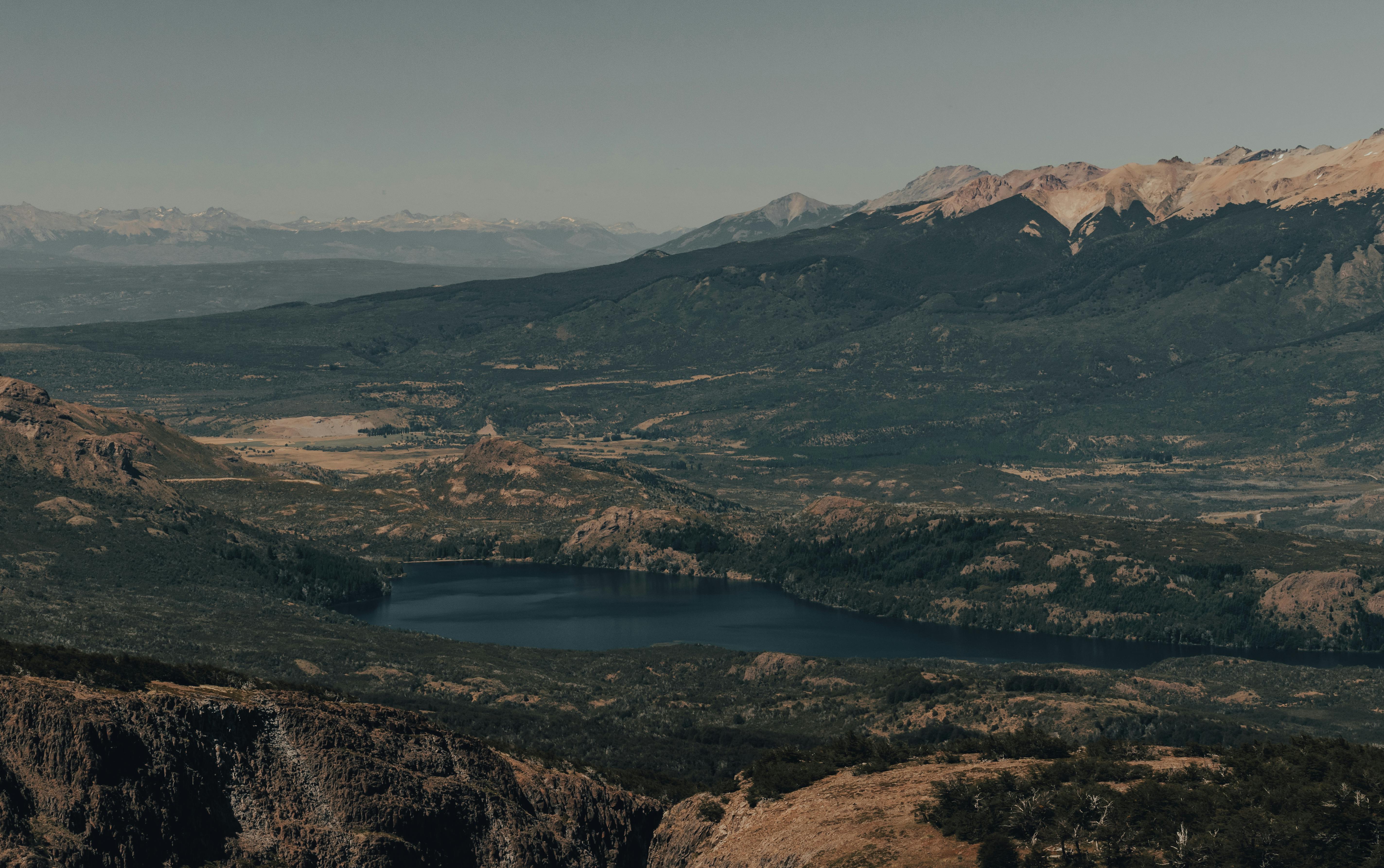 Snowy valley with trees near mountains in daylight · Free Stock Photo